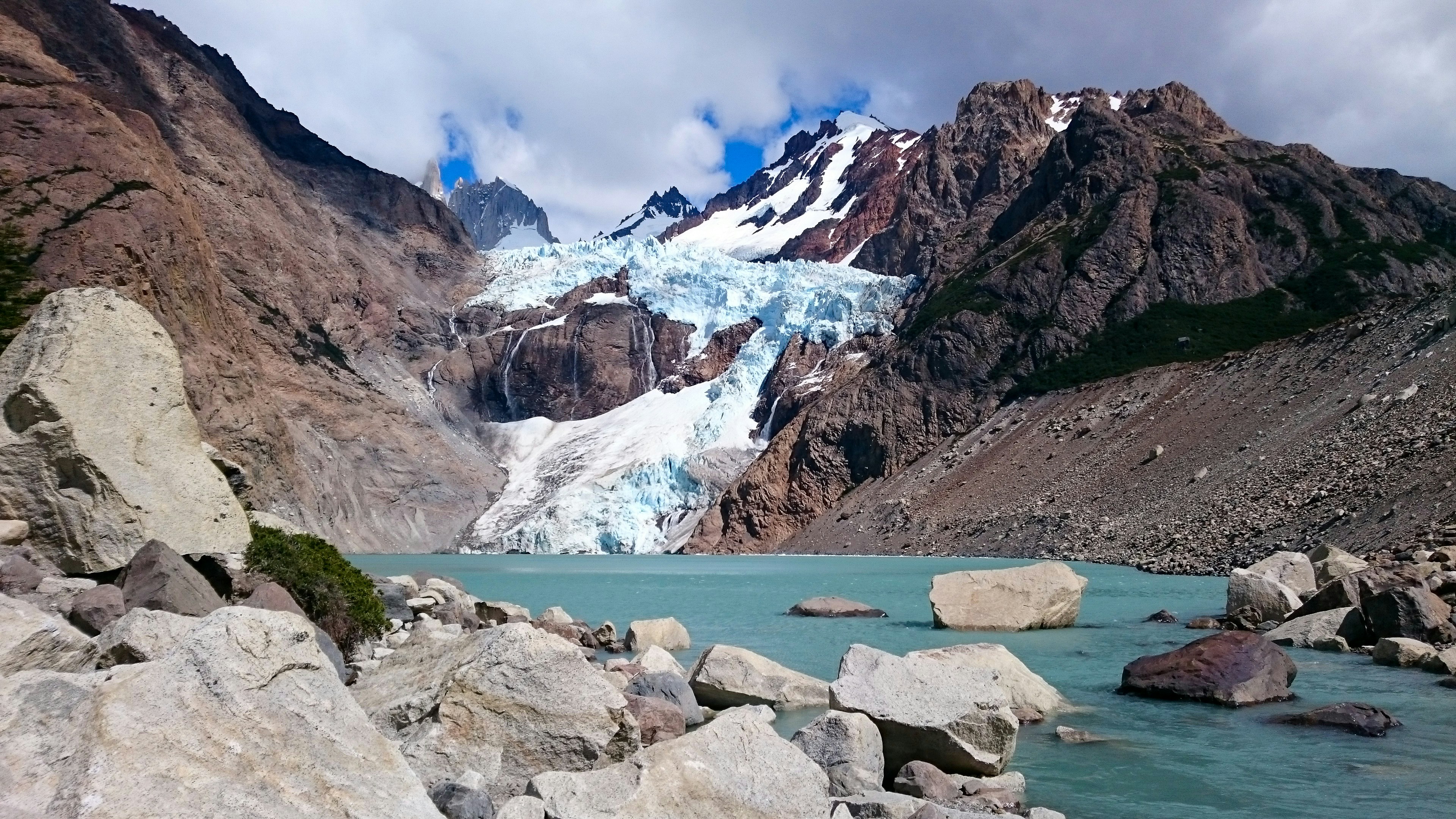 Glacial Choir: Turquoise Lake Before Snowbound Peaks