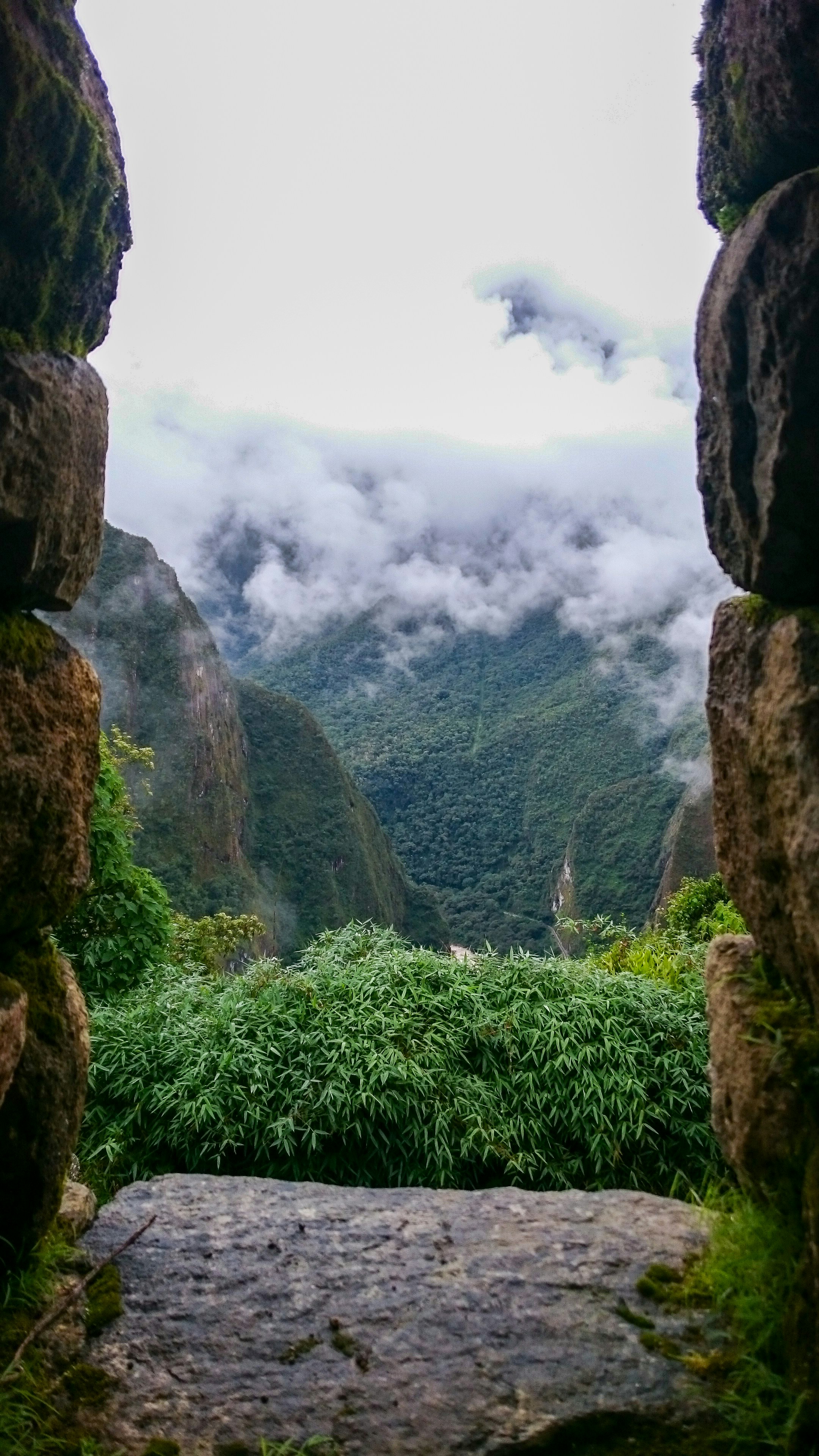 Between Stone Giants: Valley Mist Framed by Ancient Passages