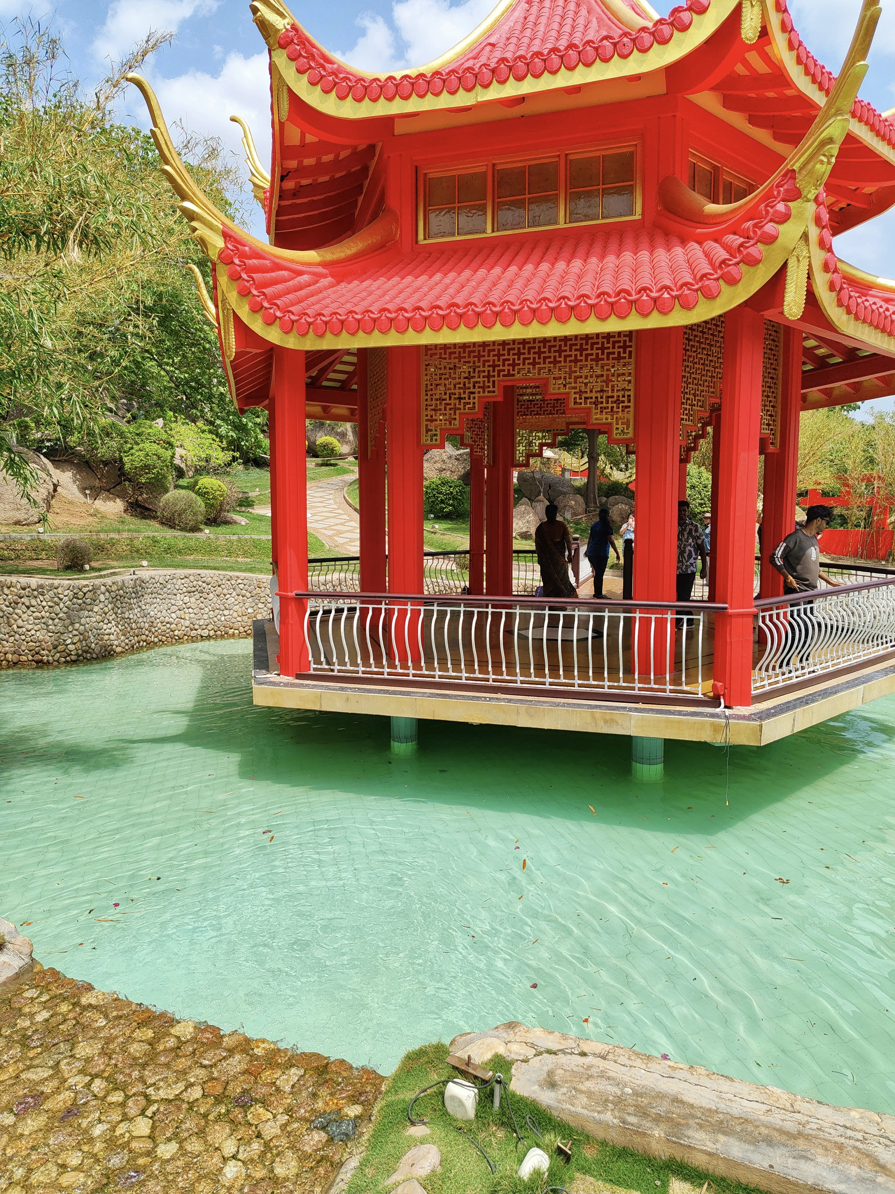 Red Pavilion over turquoise water: a tranquil oriental harbor