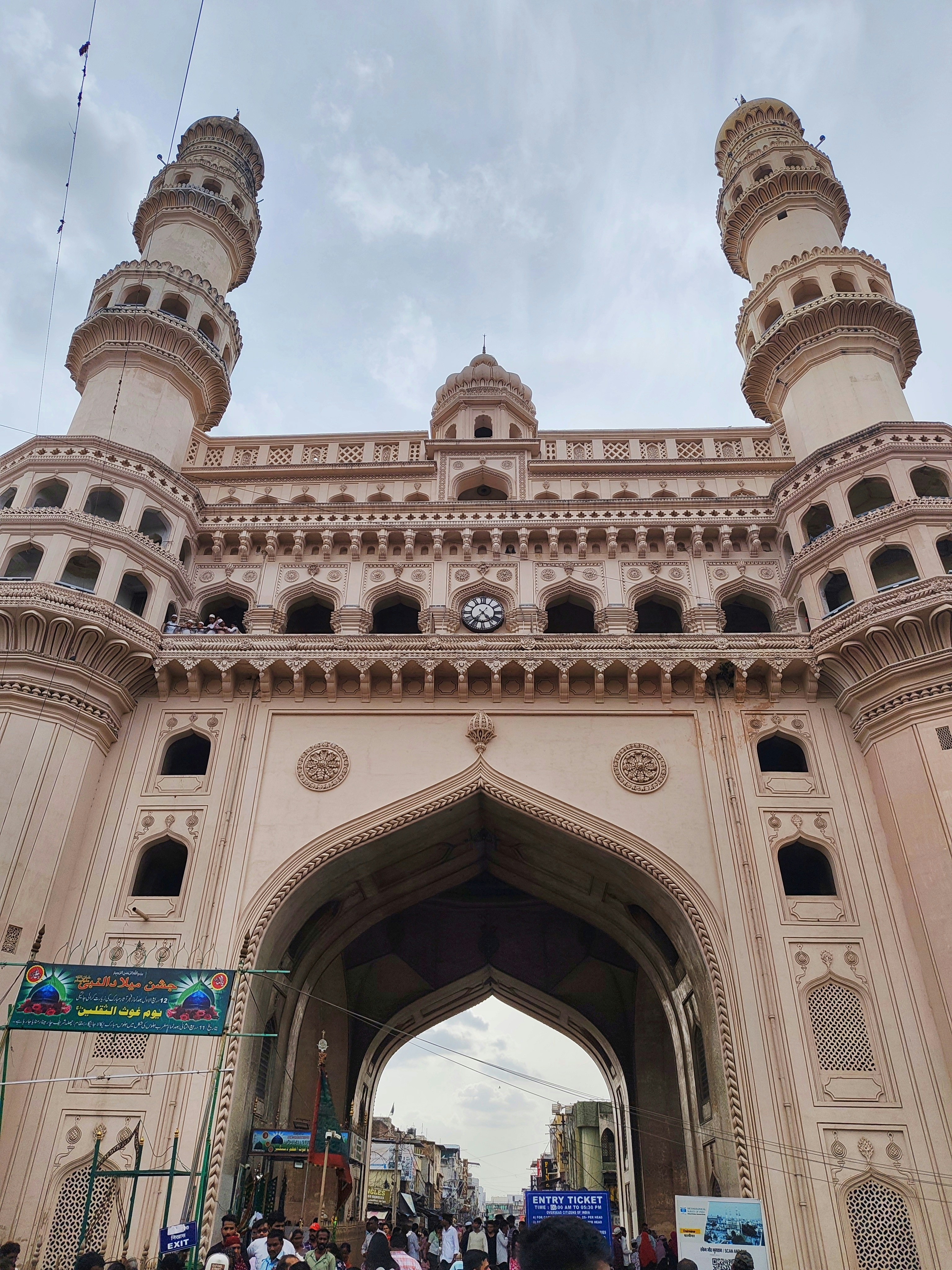 Gateway of Majesty: Carved Arches and Twin Minarets Stepping into a Sundown-Soft Sky
