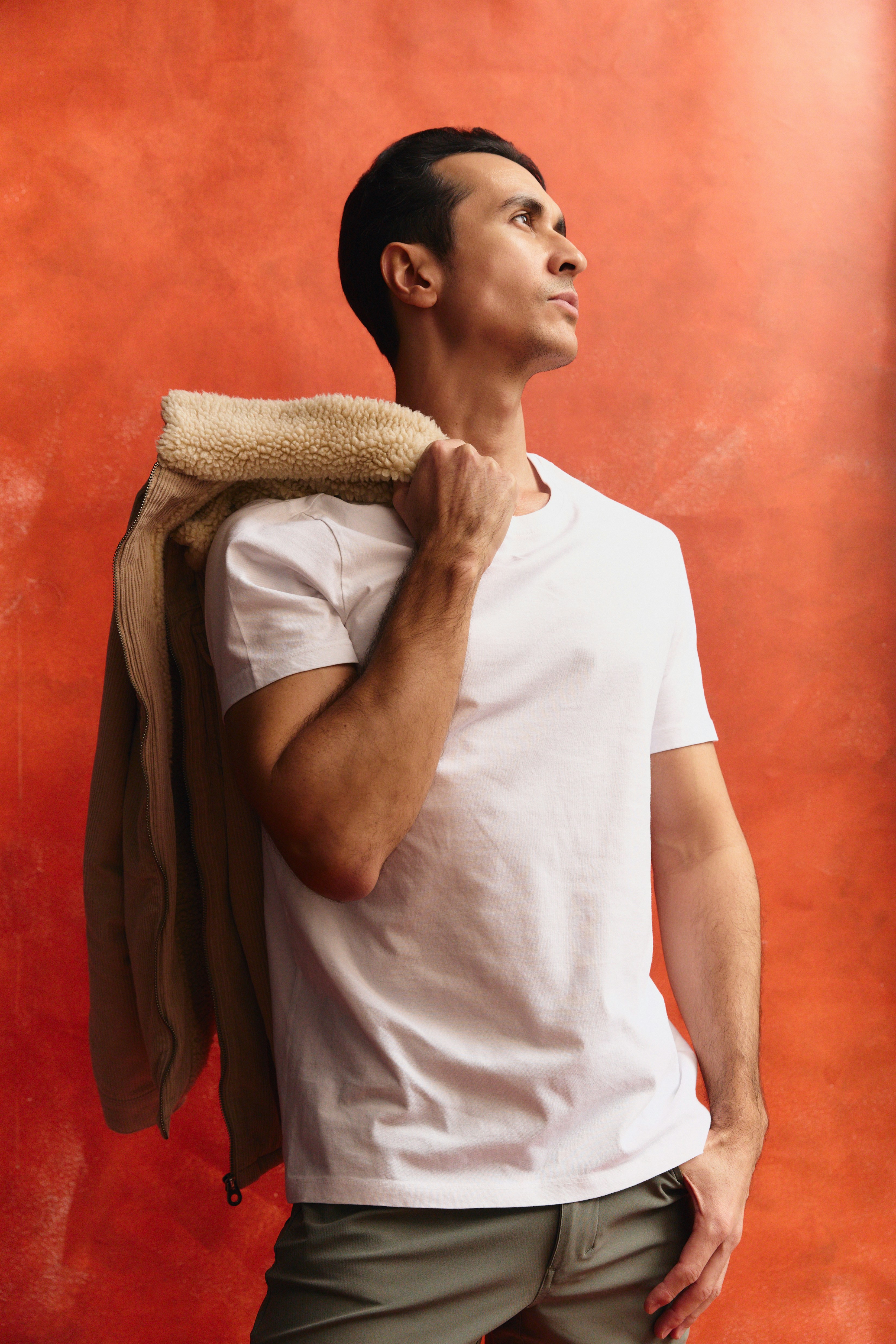 Portrait in Warm Amber: A Man with a Denim Jacket Over Shoulder