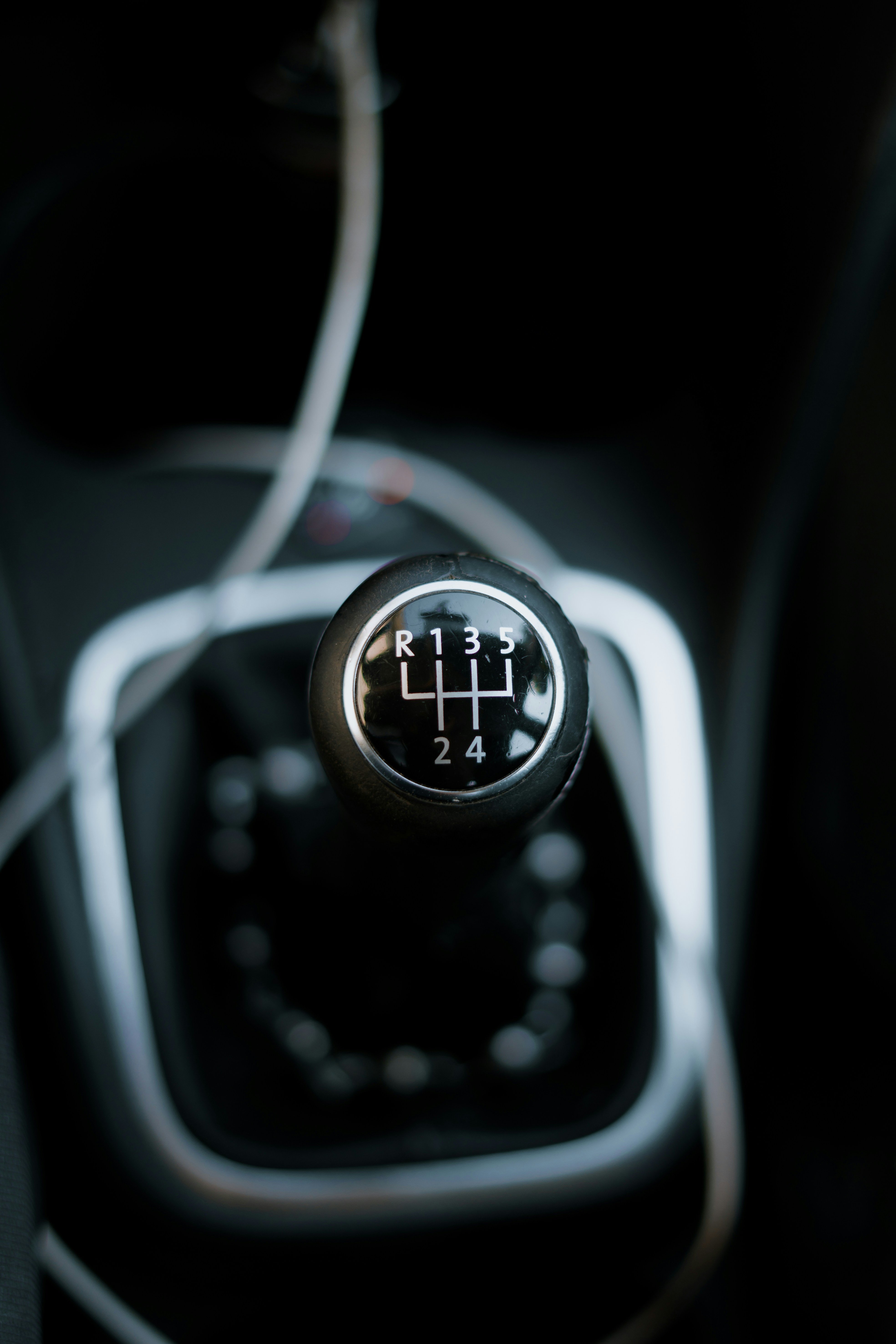Gearshift Portrait: The Silvery Knob Under Soft Spotlight