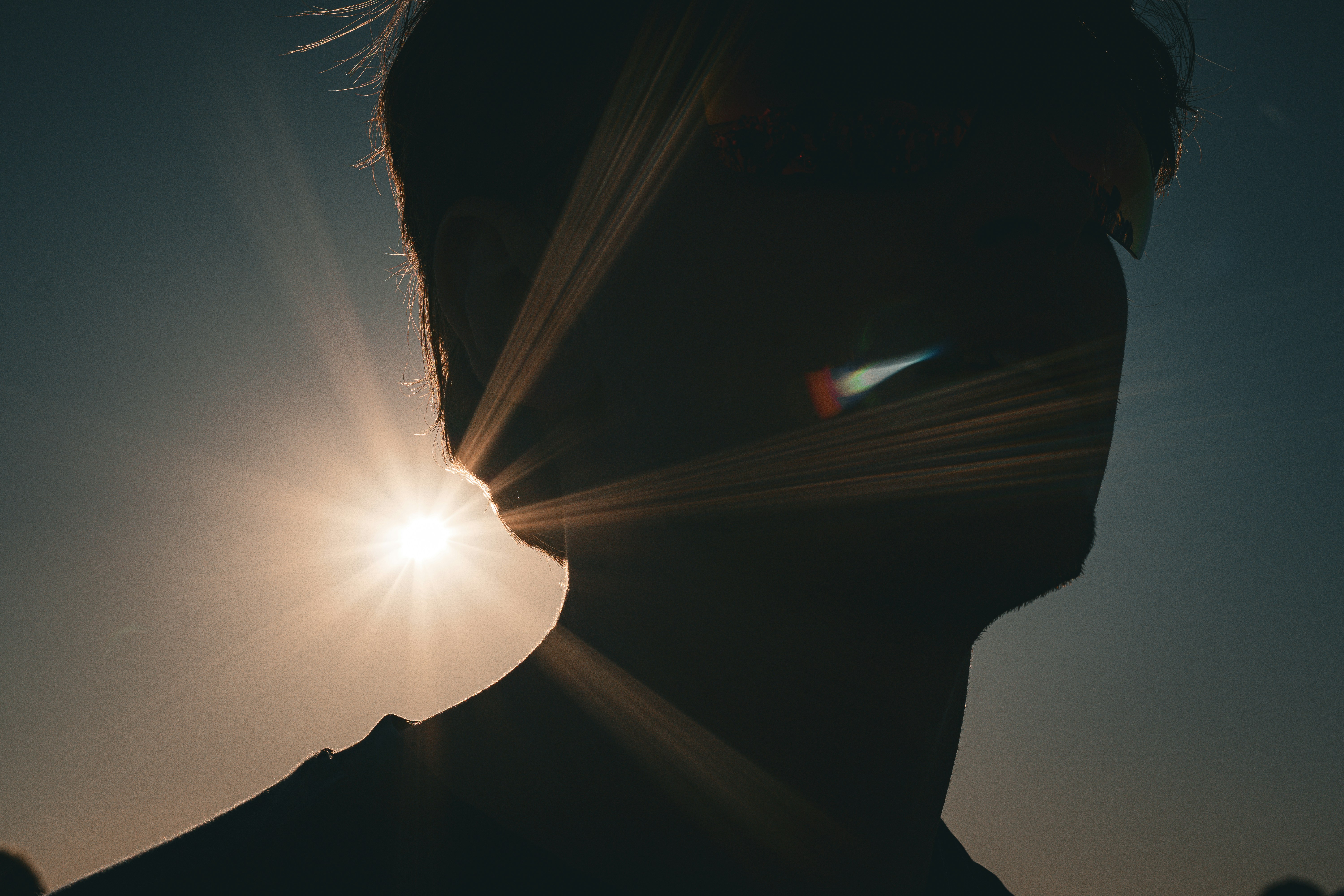 Silhouette at Sunset: A Quiet Moment with Sunburst Framing