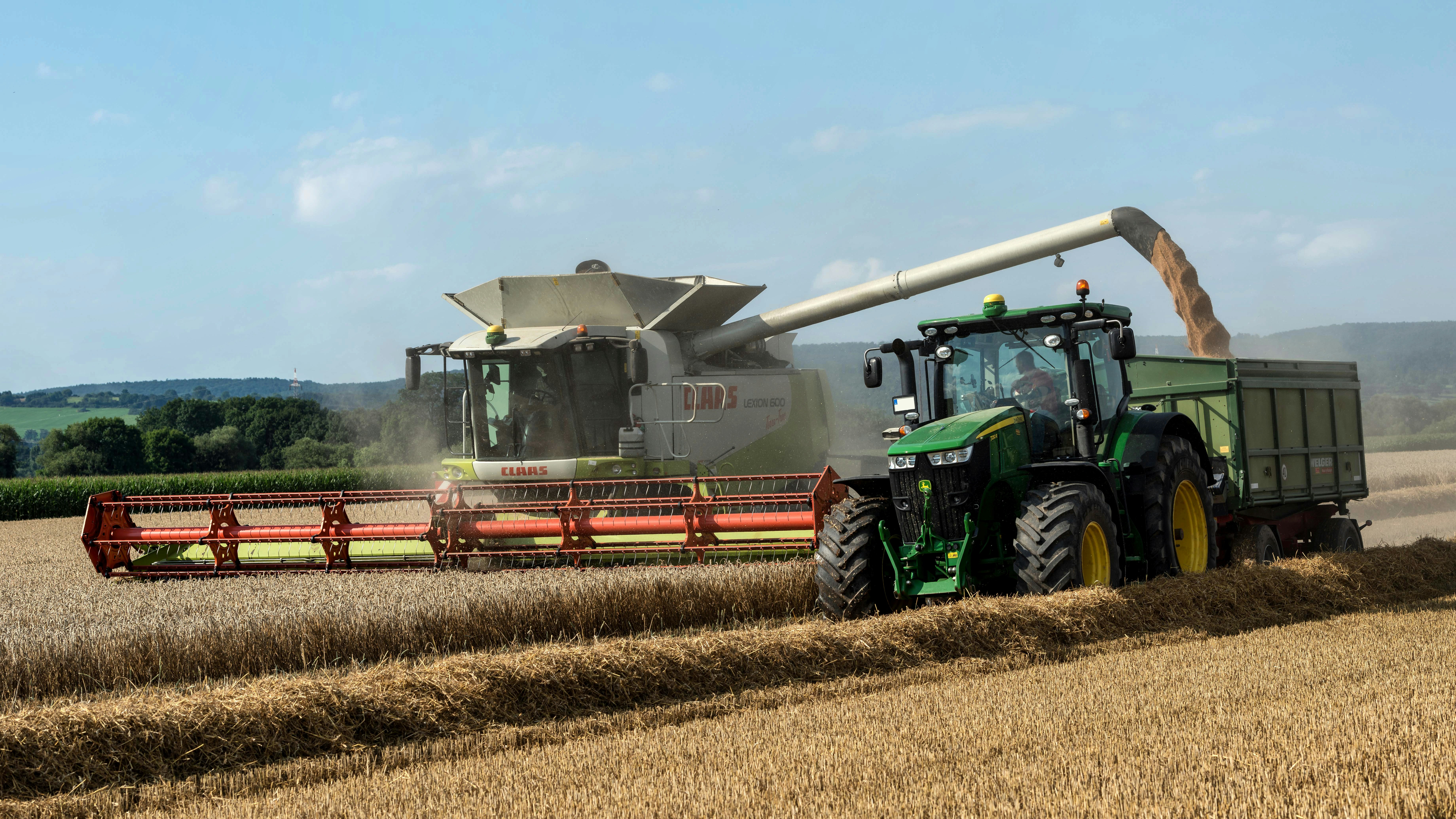 Harvest Symphony: Green Tractor at the Siloed Edge of Field