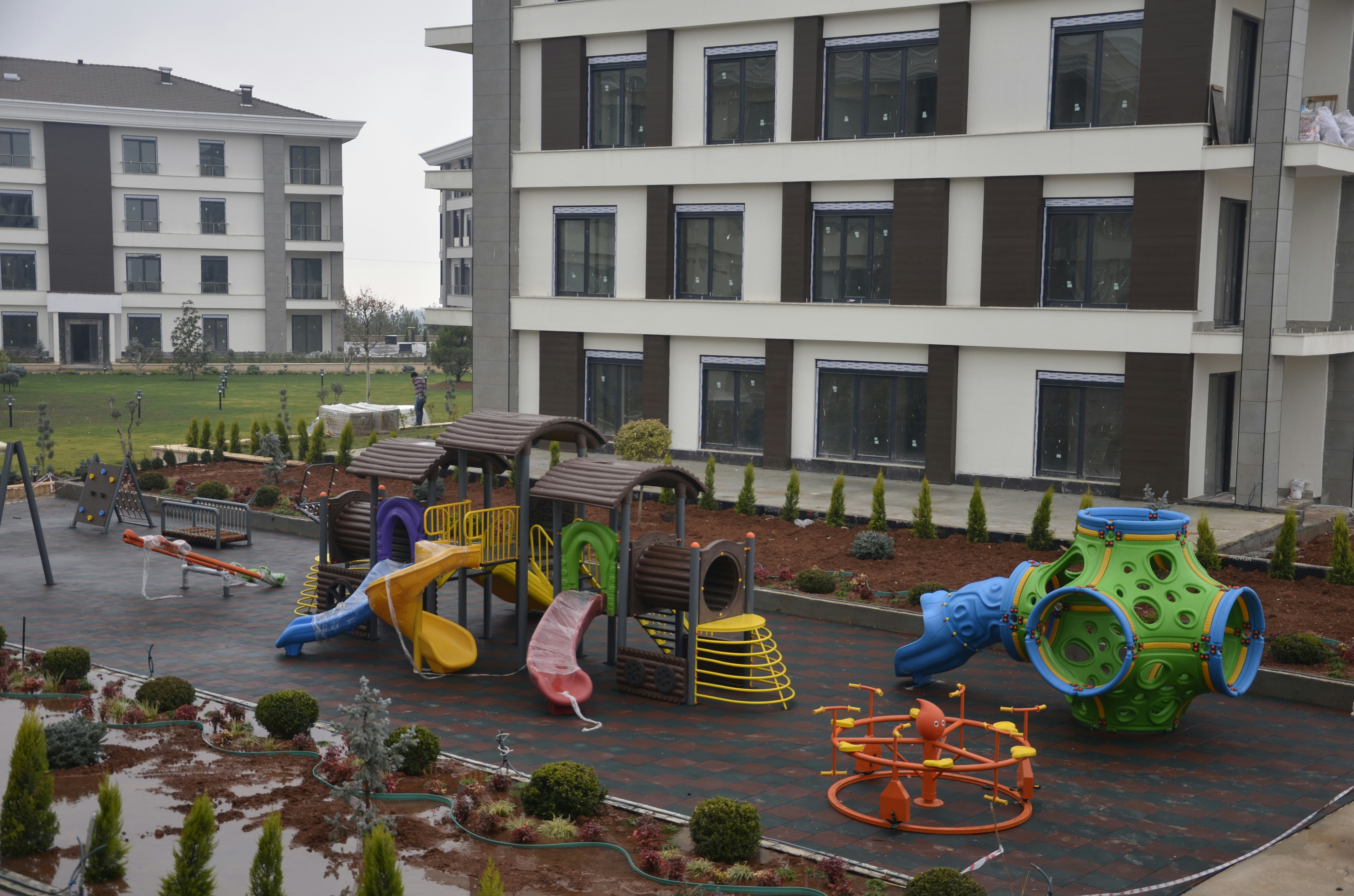 Curved Slide Playground Under Modern Residential Backdrop