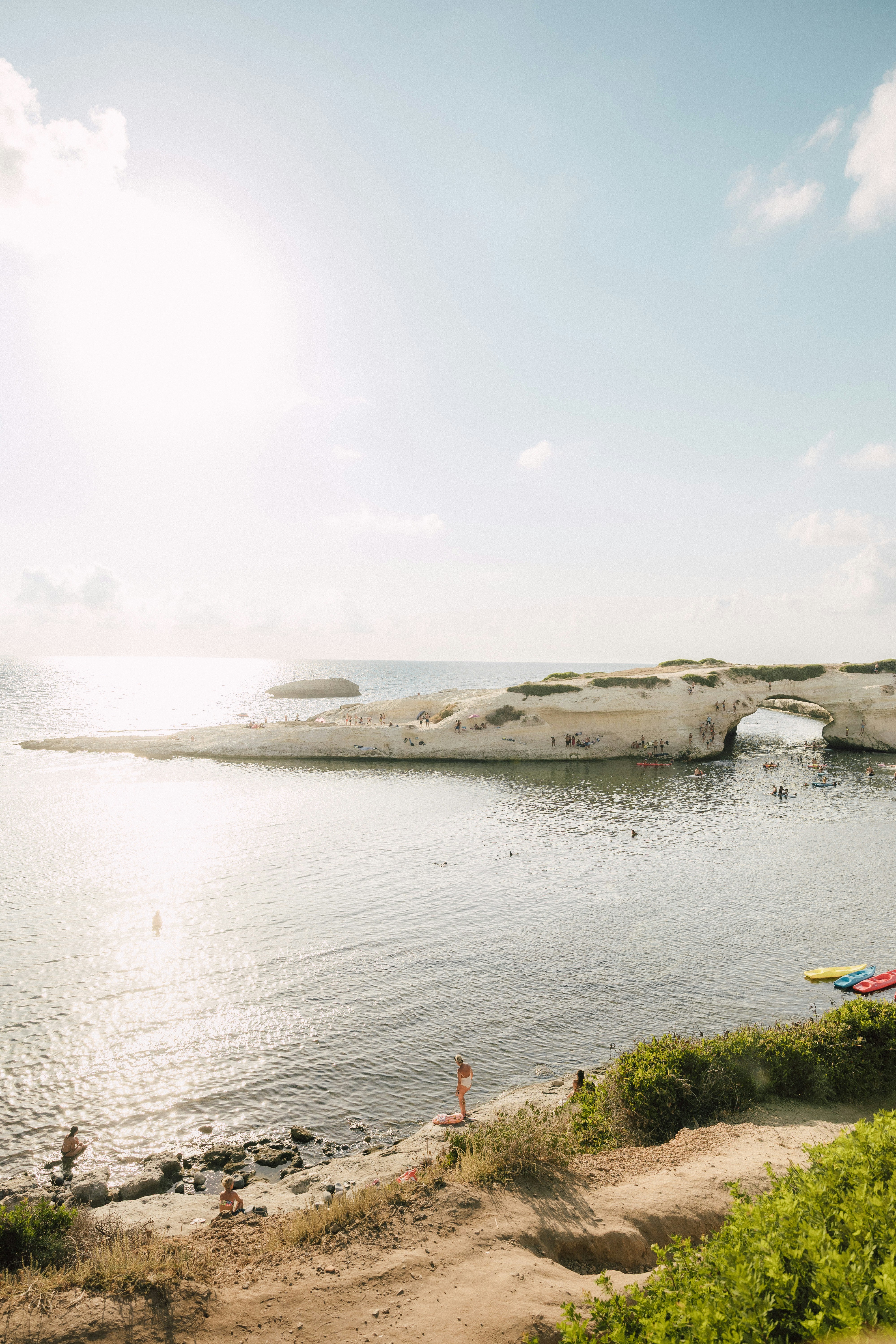 Sunlit cove: a quiet shoreline under a radiant sky