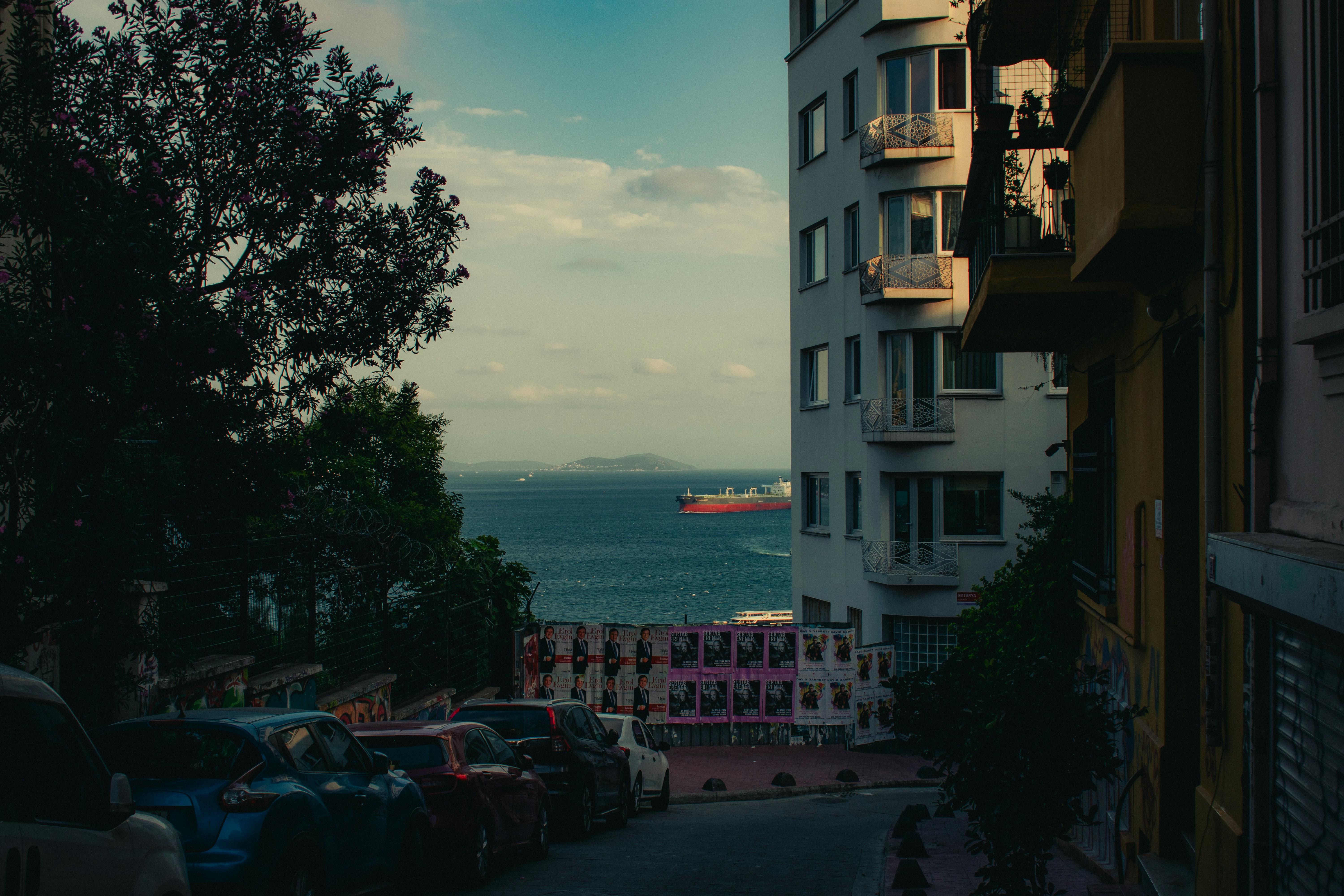 Coastal Street Framed by Towers: A Harbor View Between Buildings