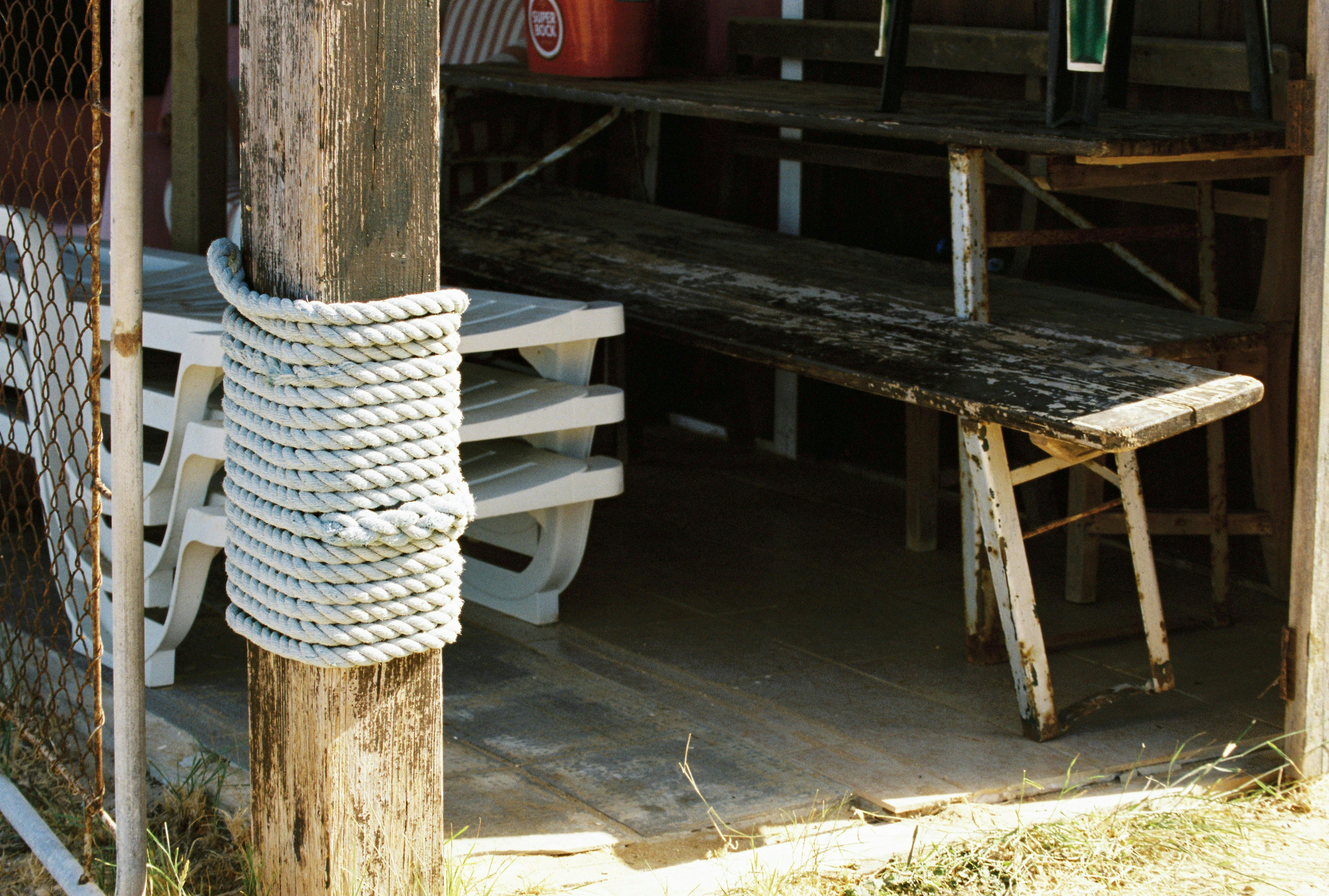 Rugged Dockside Corner: Weathered Wooden Post and Benches