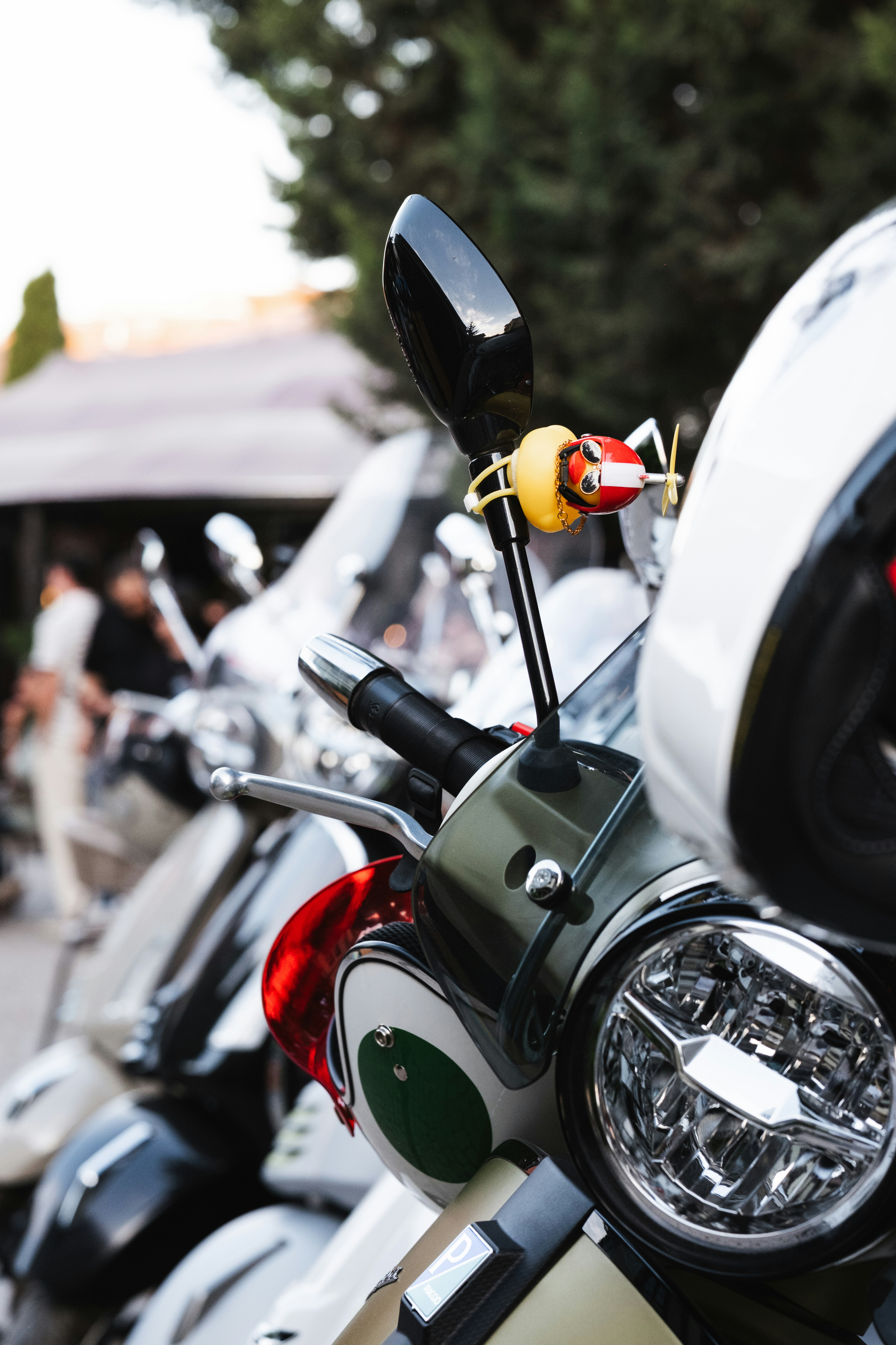 Chrome and chrome: A motorcycle headlight meets a glossy street scene