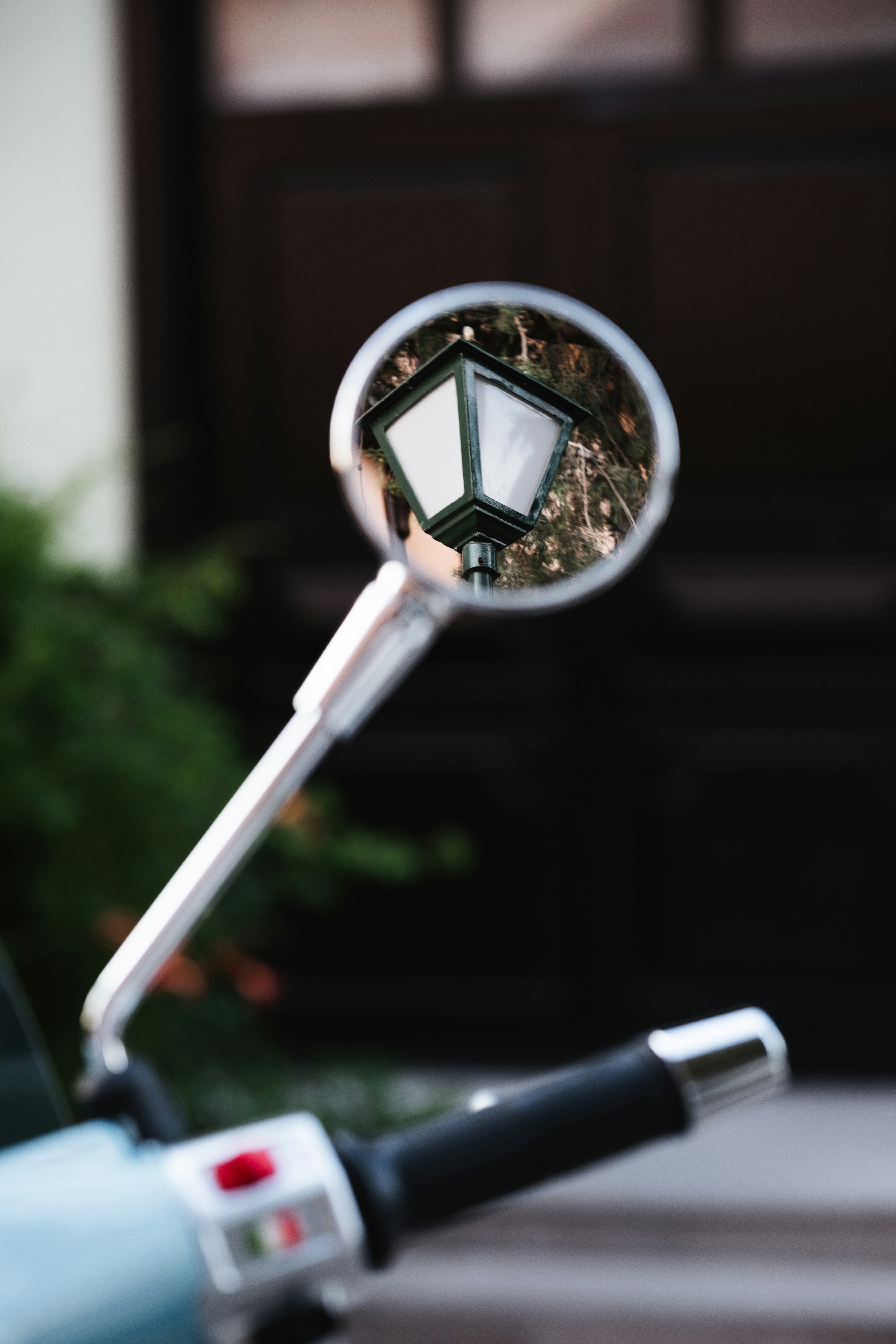 Lens Circle: A Magnified Streetlamp Reflected in a Floating Handheld Mirror
