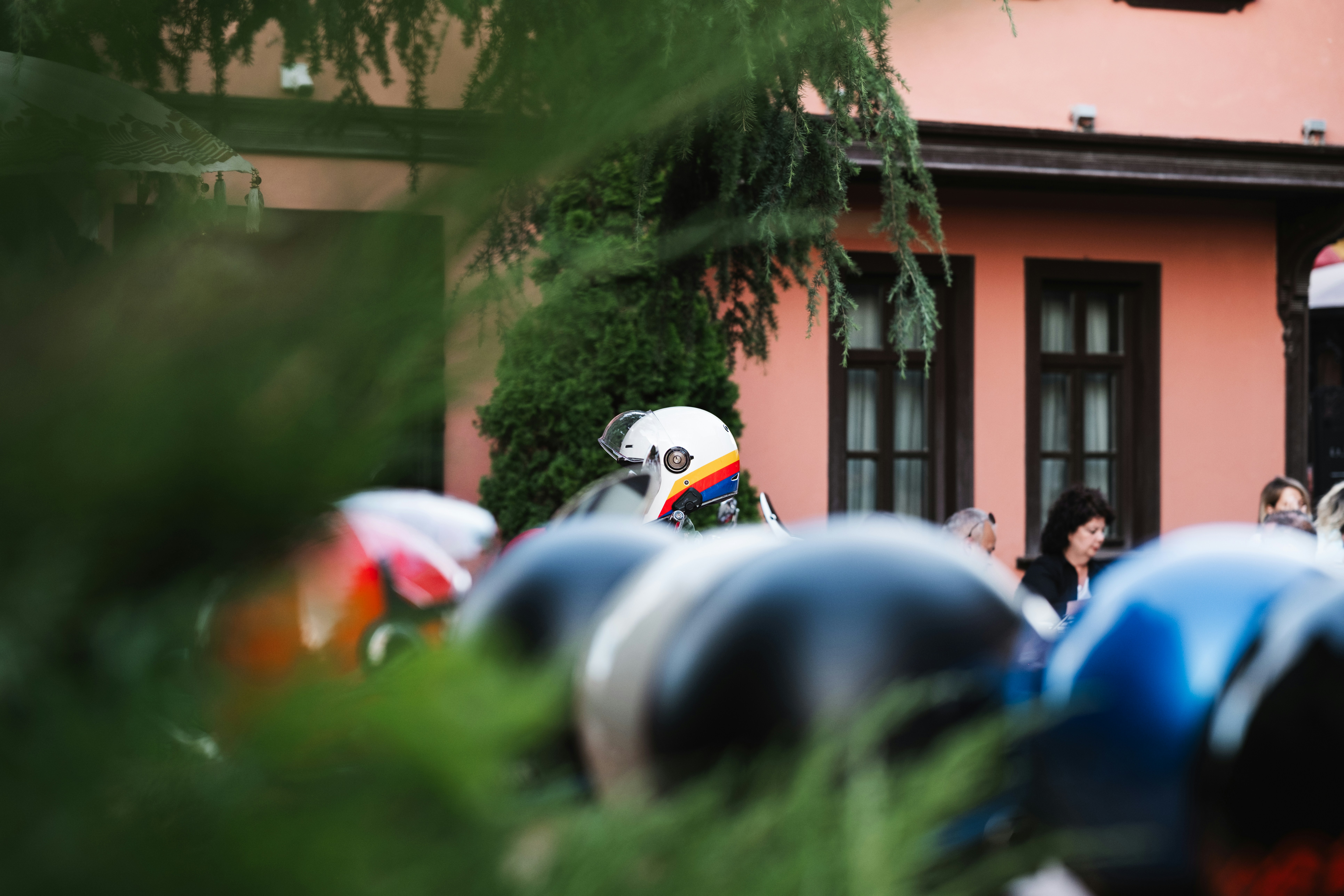 Helmeted Focus: A Quiet Moment Among the Parked Rides
