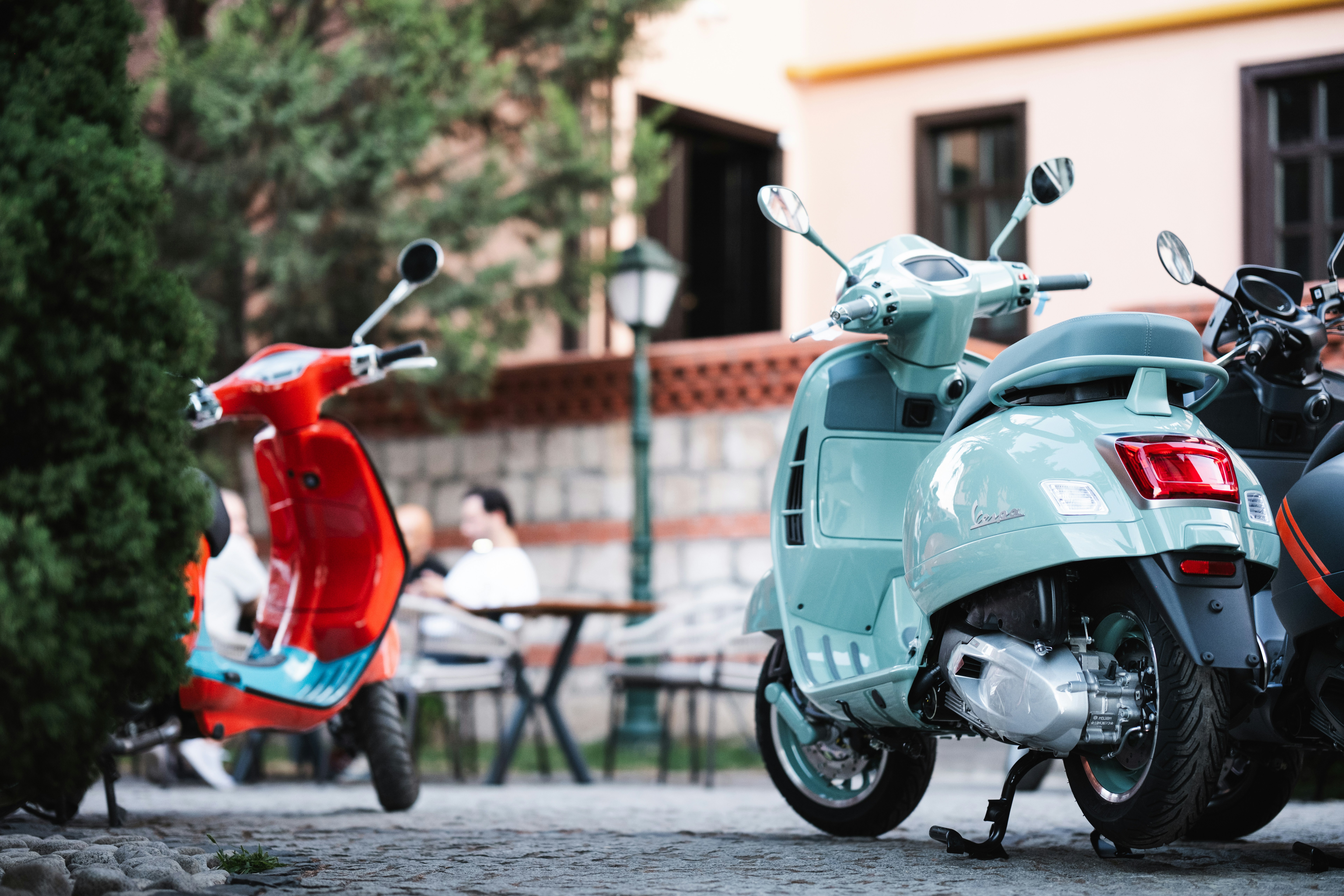 Quiet Street with Colorful Scoots: A Pair of Mopeds Creating a Small Gallery