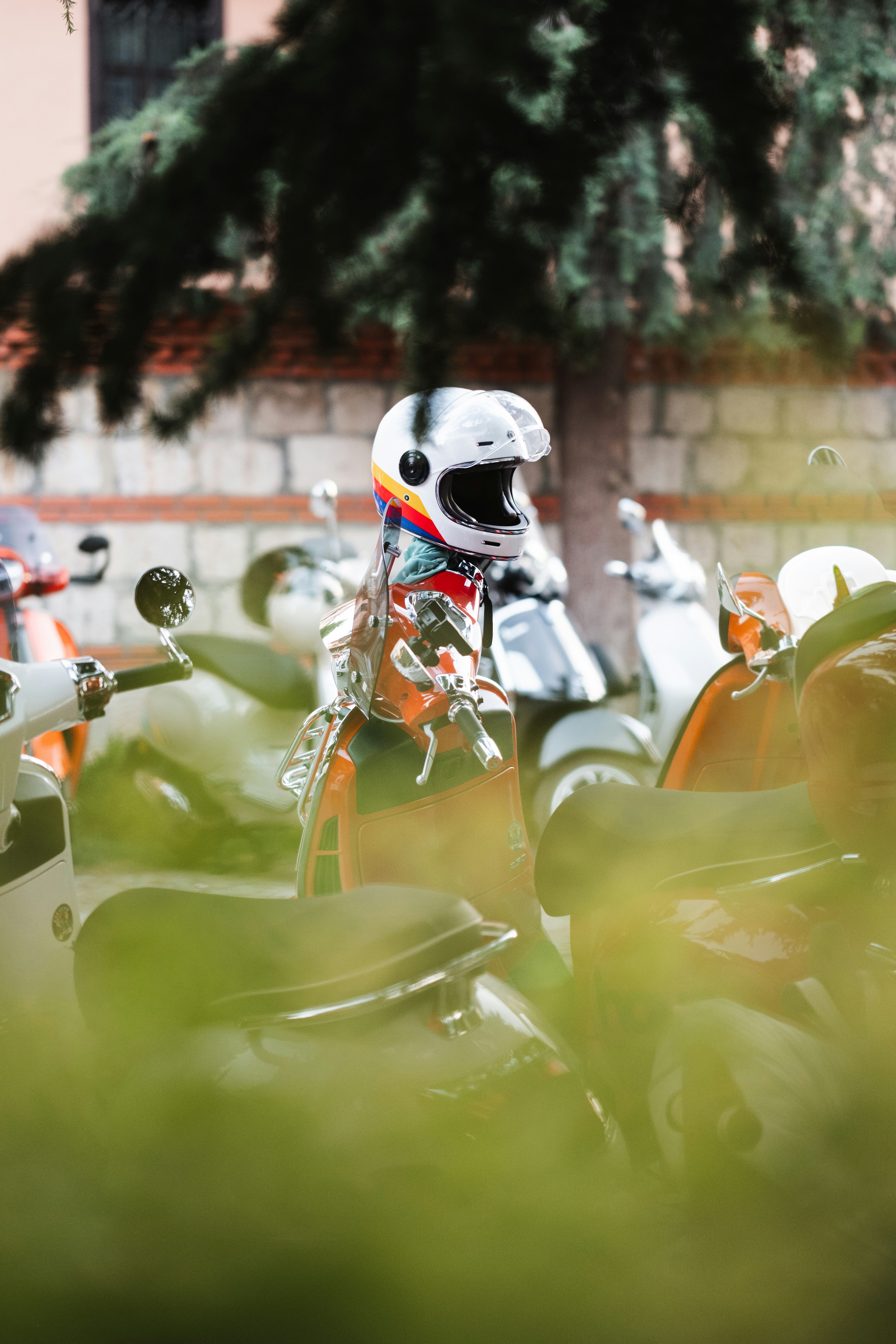 Helmeted Rider Emerges from a Green Frame of Bokeh and Bikes