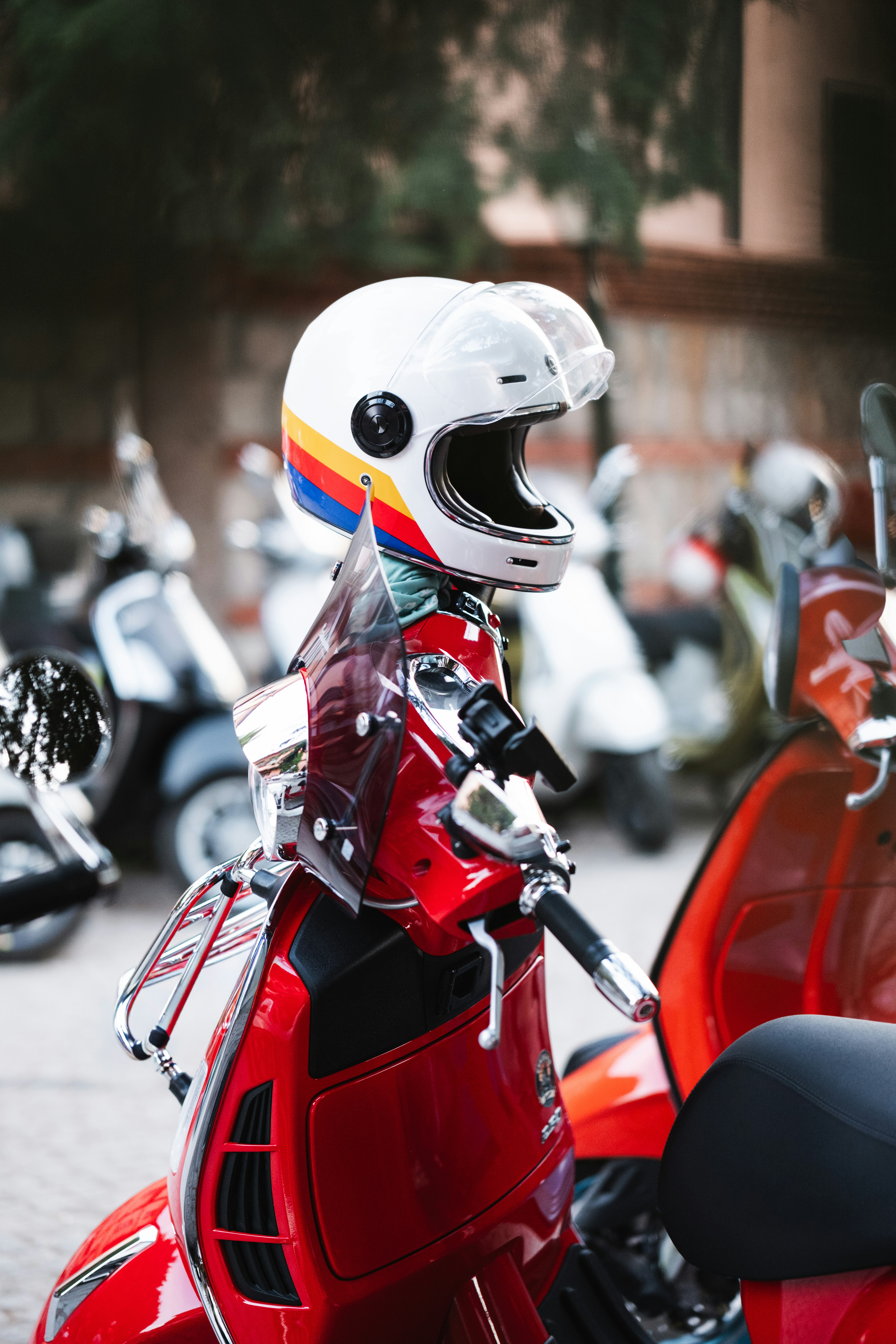 Helmeted Rider in Vibrant Red Scooter Scene