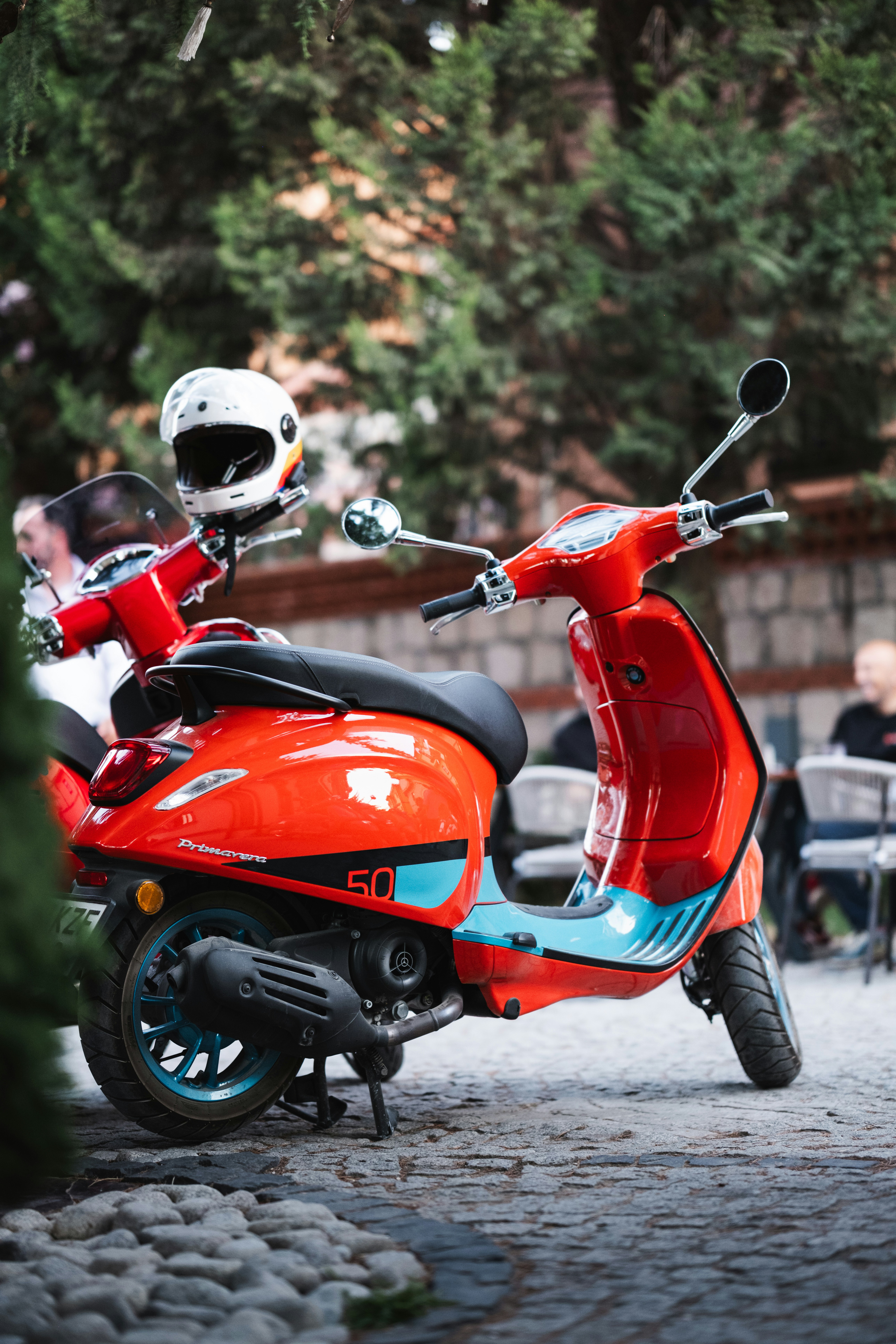 Vivid Red Vespa at Rest: A City-Cobbled Moment