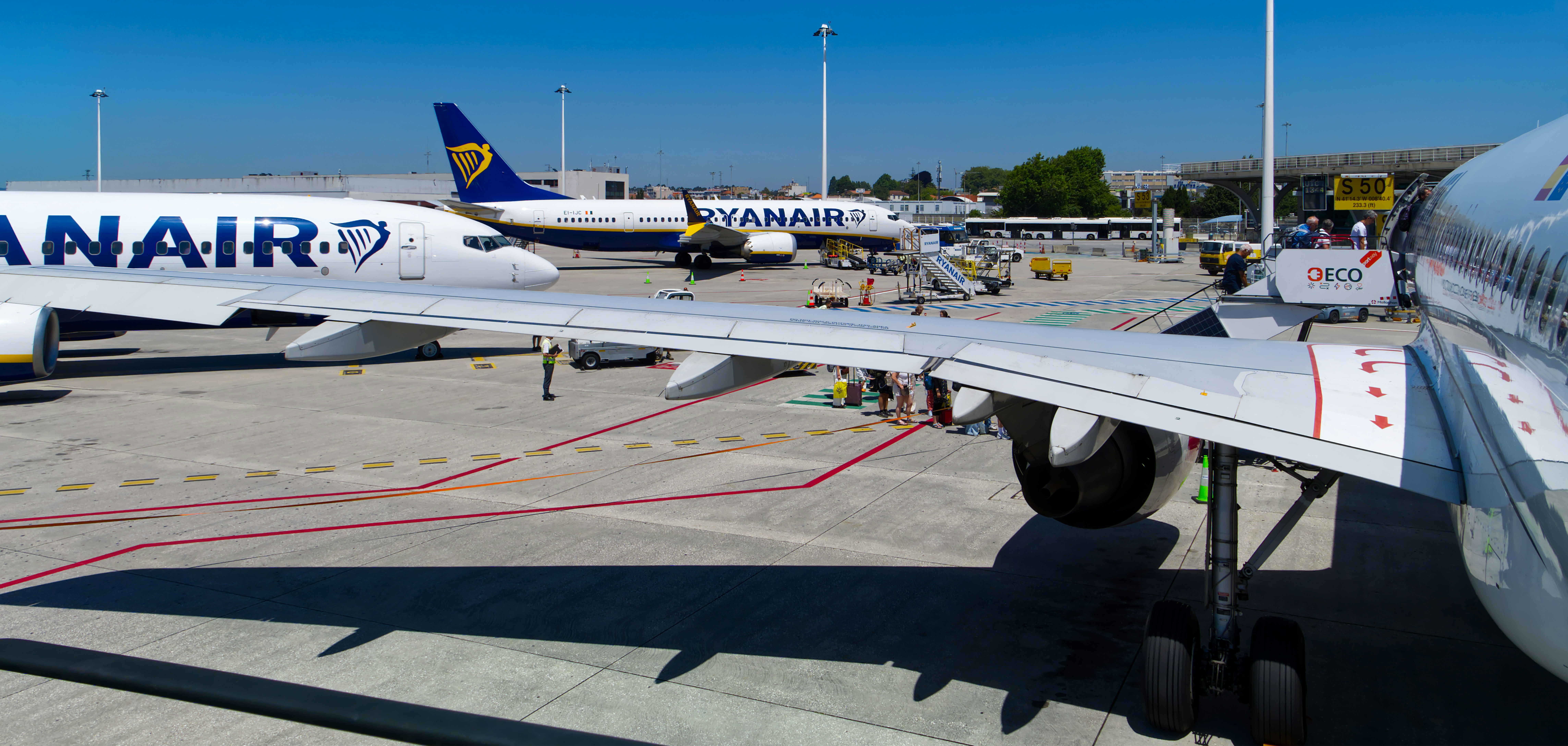 Racing Wings at Dawn: A Ryanair Stand with Wide Tarmac Grit