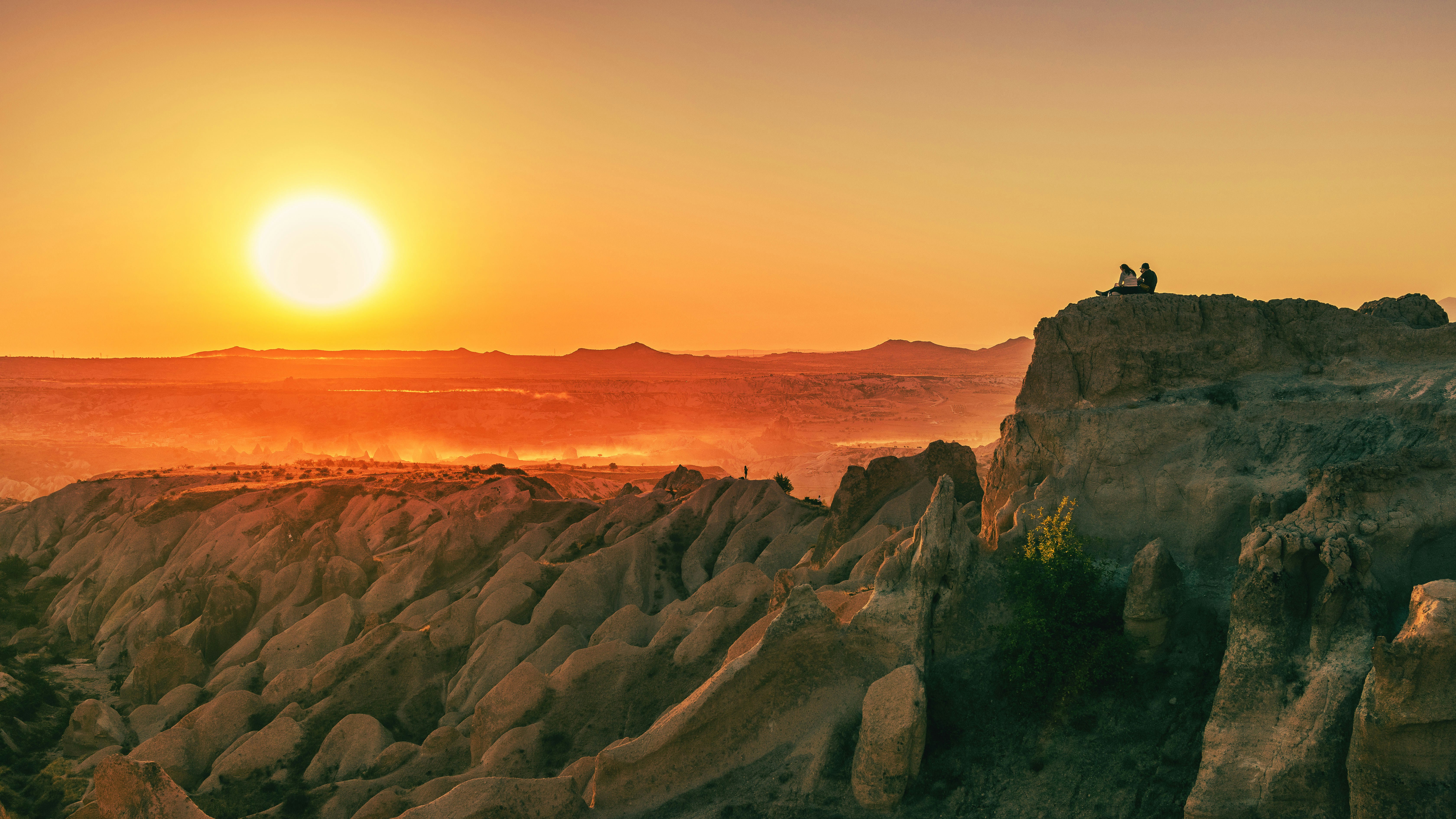 Sunset Over Jagged Cliffs: Lions at the Edge