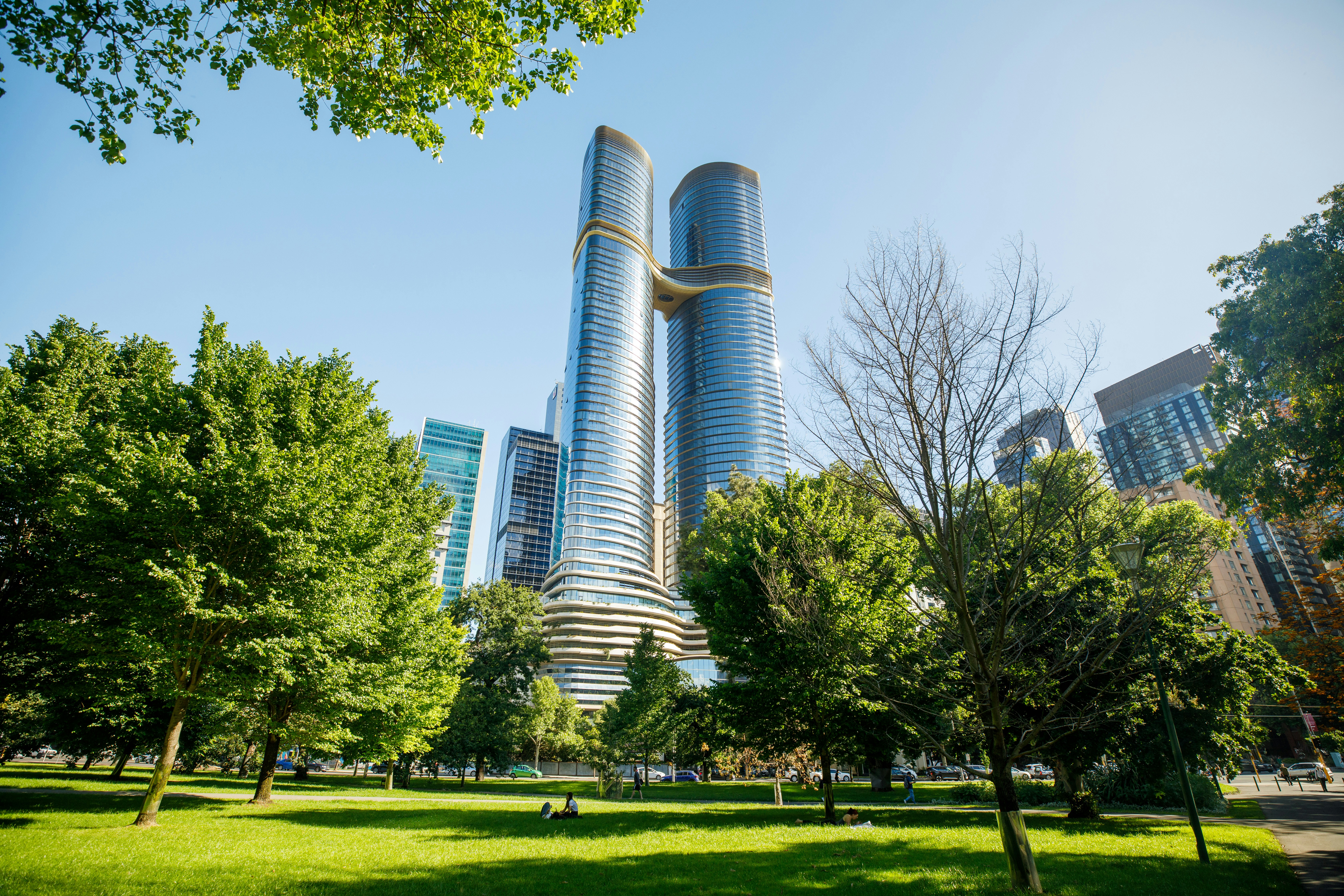 Twin Skyscrapers Rising Above a Green Urban Oasis