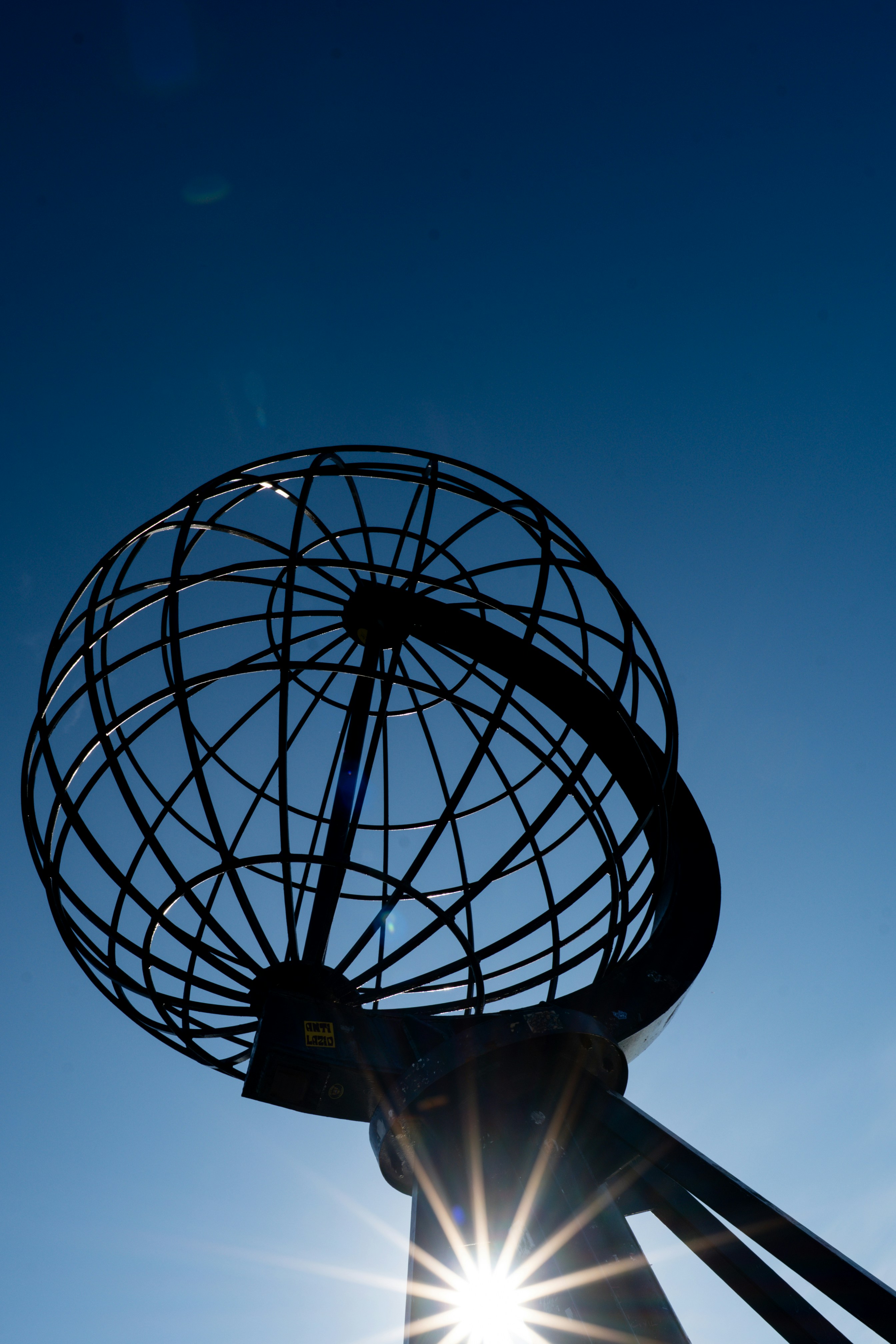 Steel Globe at Dusk: A Starburst of Angled Circles