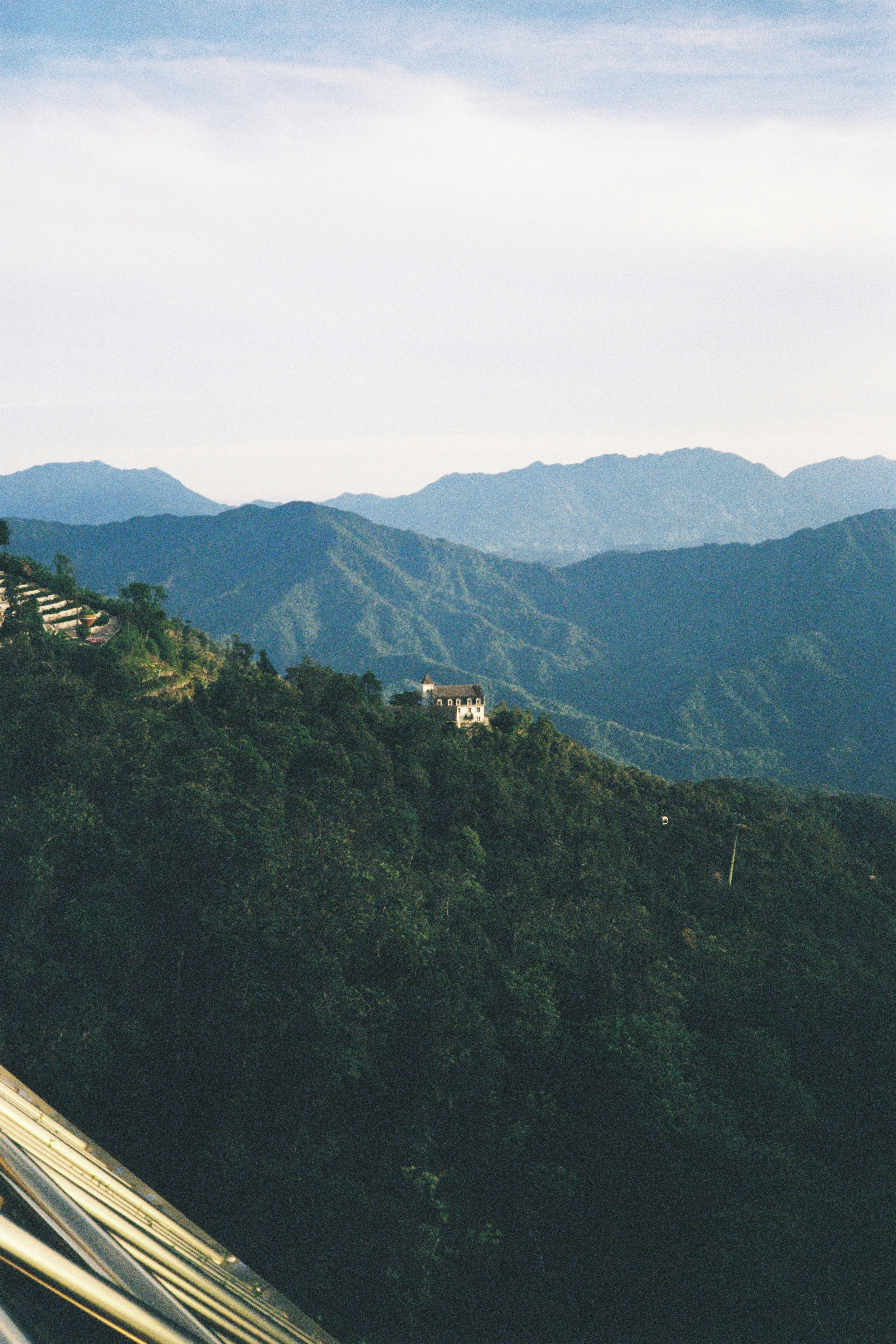 House on the Crest: A Quiet Glimpse Across the Mountain Tapestry