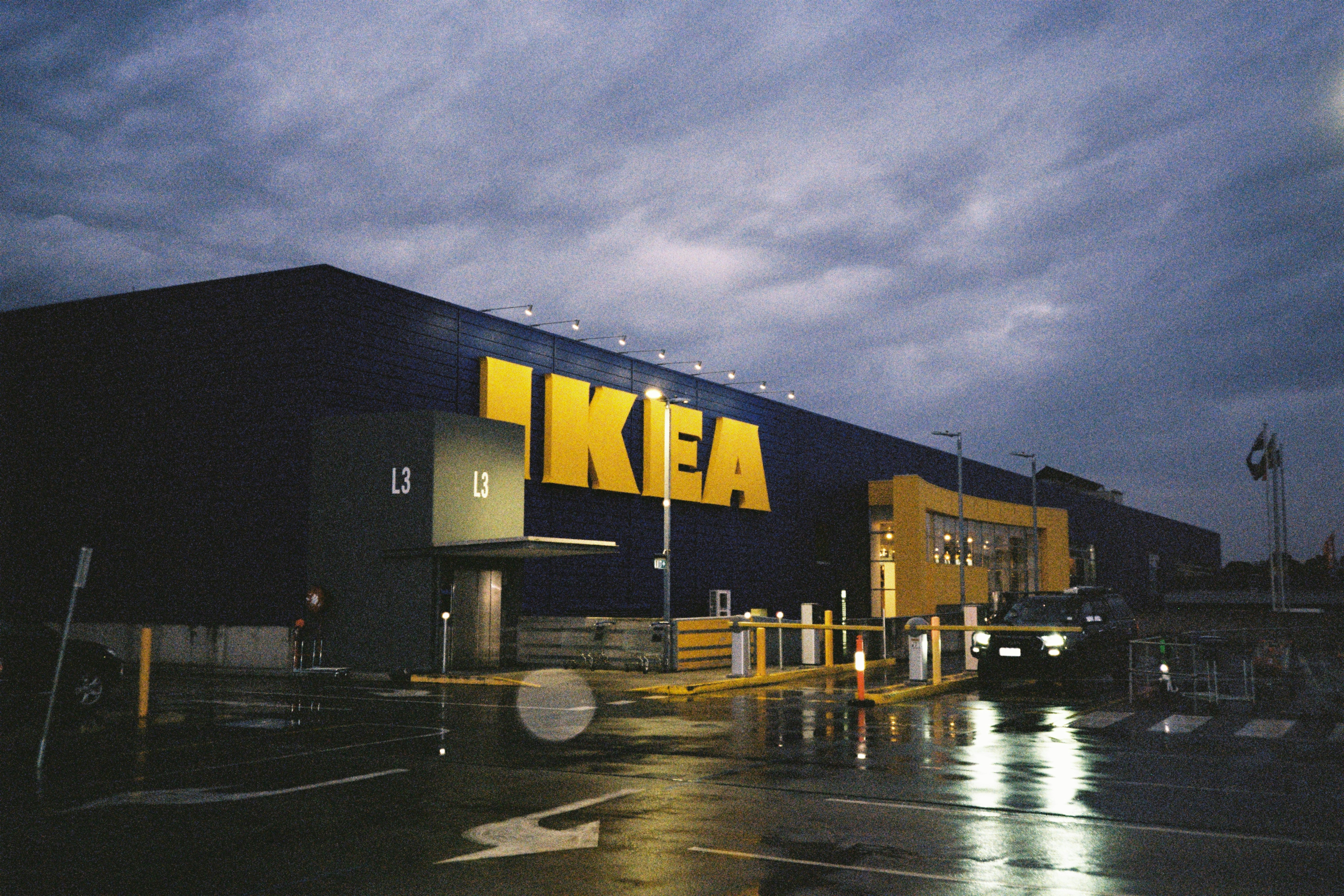 IKEA Neon Glow Across a Wet Parking Lot