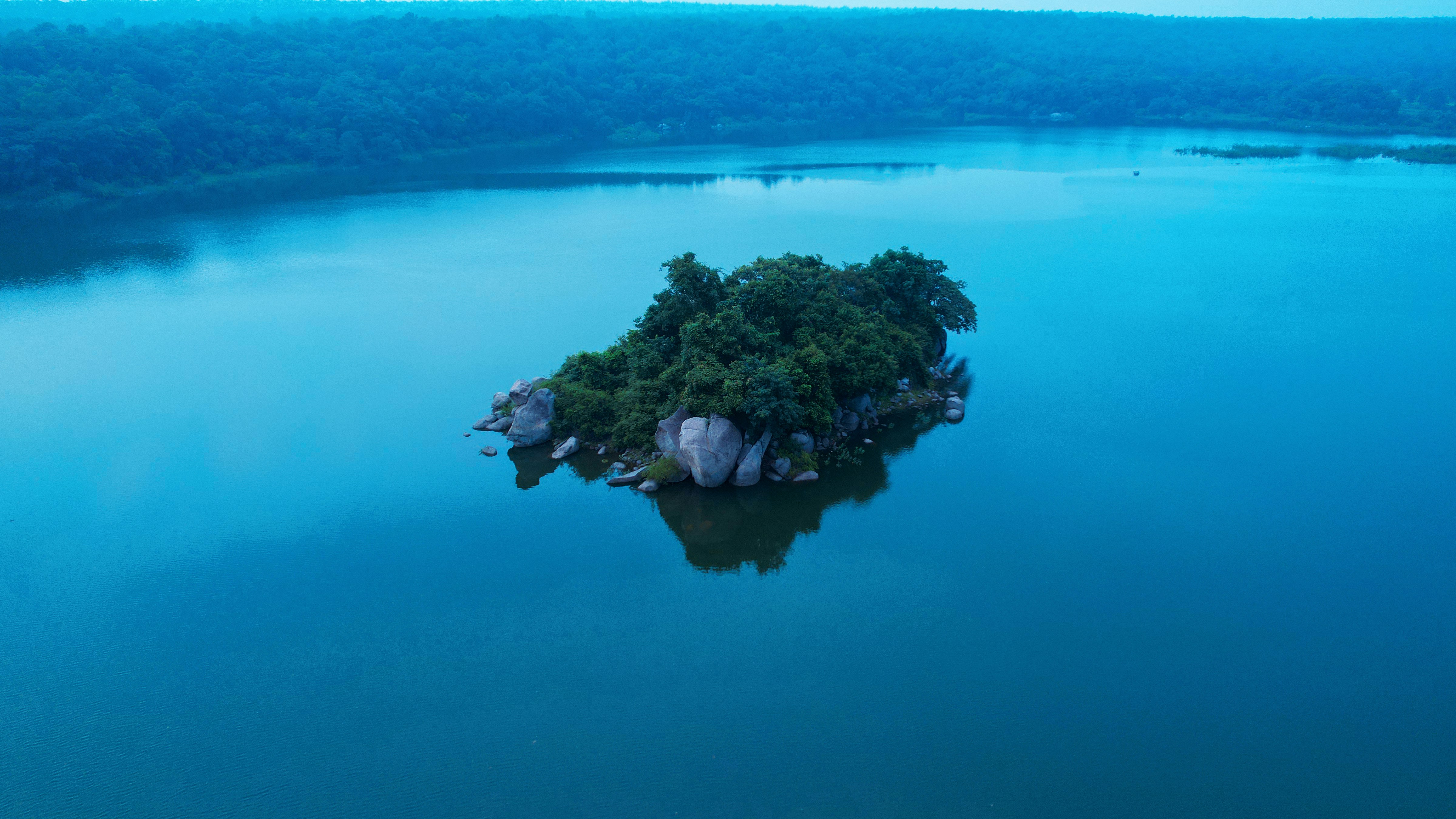 Island Emerges from Glassy Blue Waters