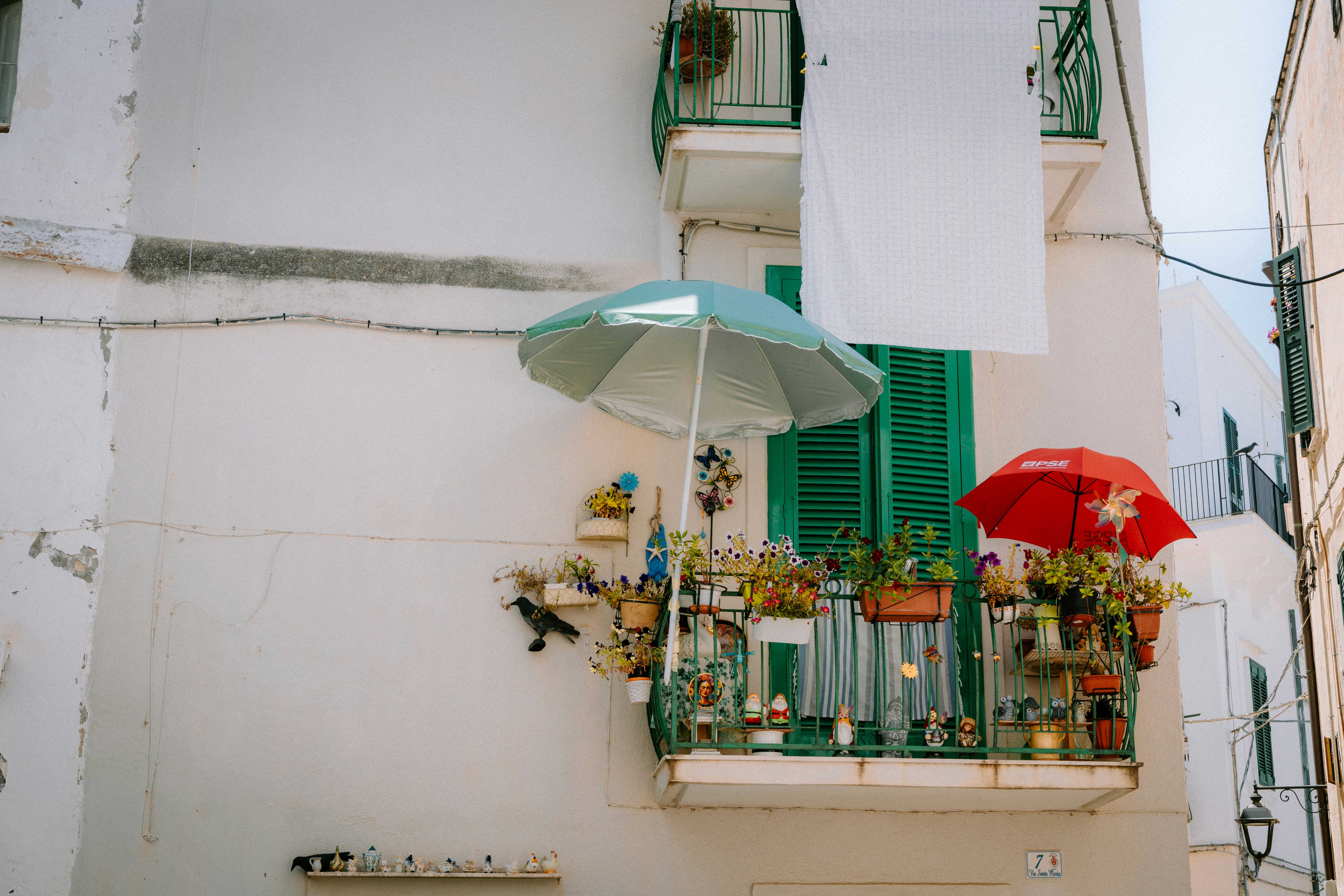 Balcony Blooms Under Colorful Parasol Awnings