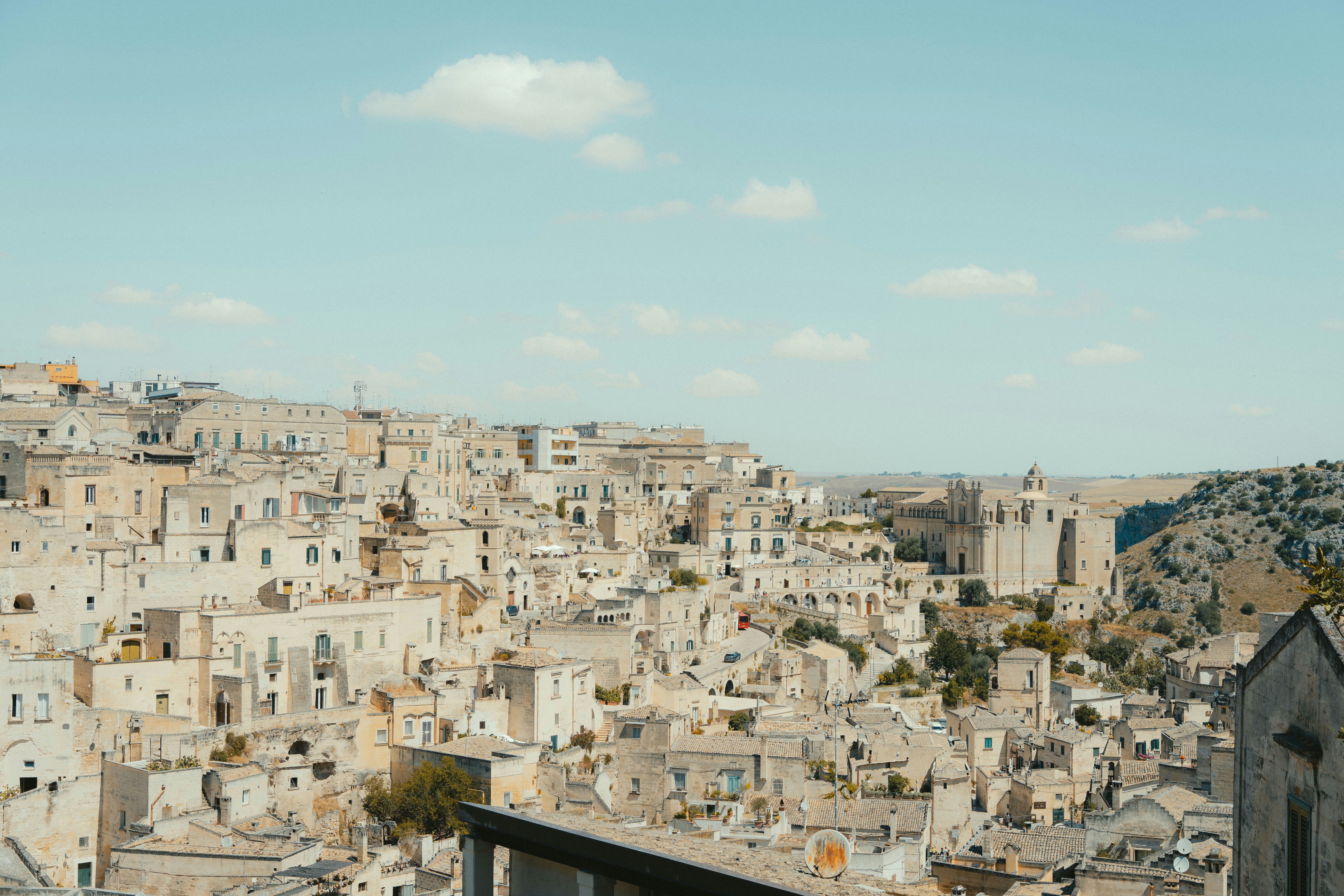 Sunlit Stone City: A Quiet Terrace Framed by Terraced Limestone