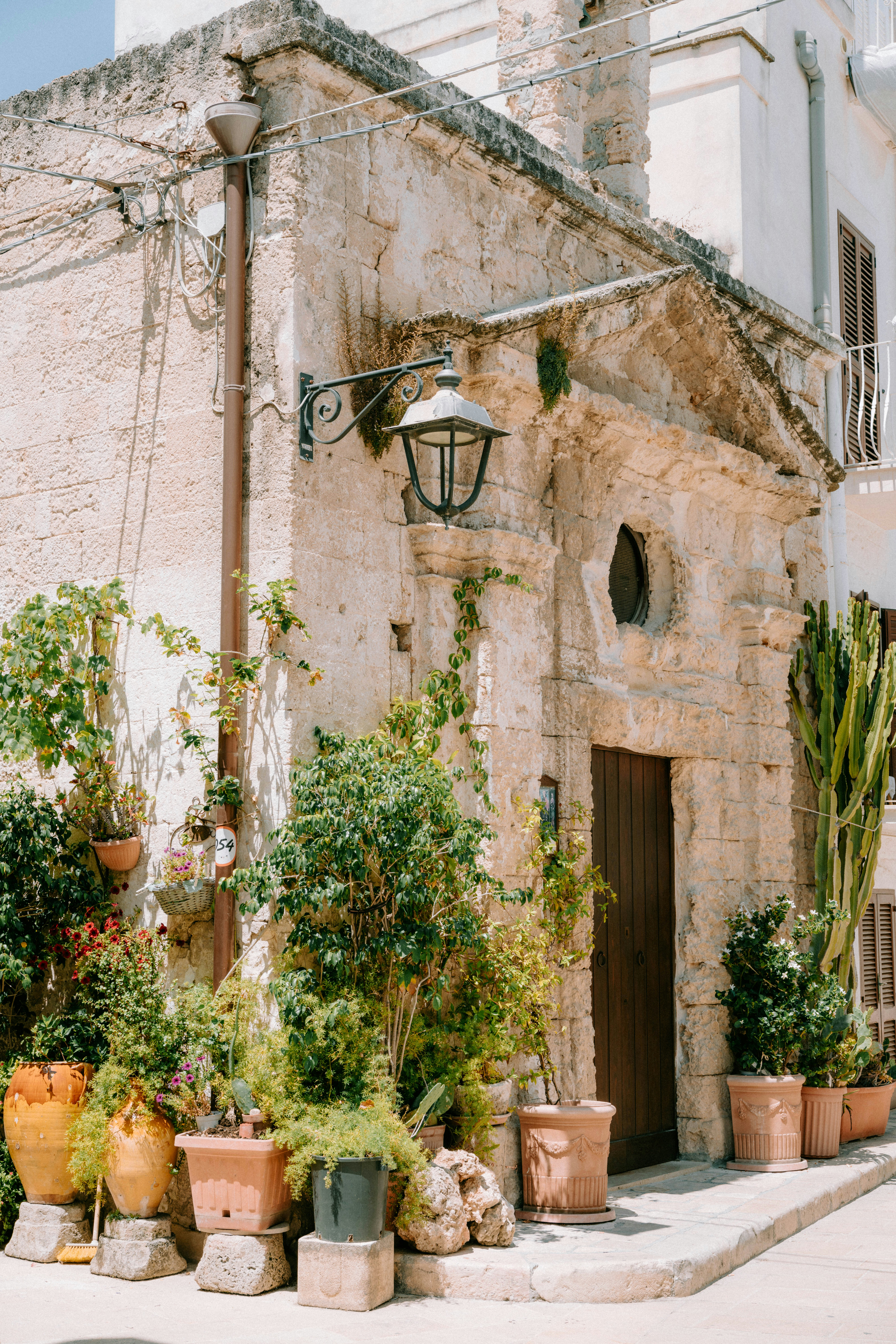 Sunlit Facade Oasis: A Rustic Mediterranean Corner