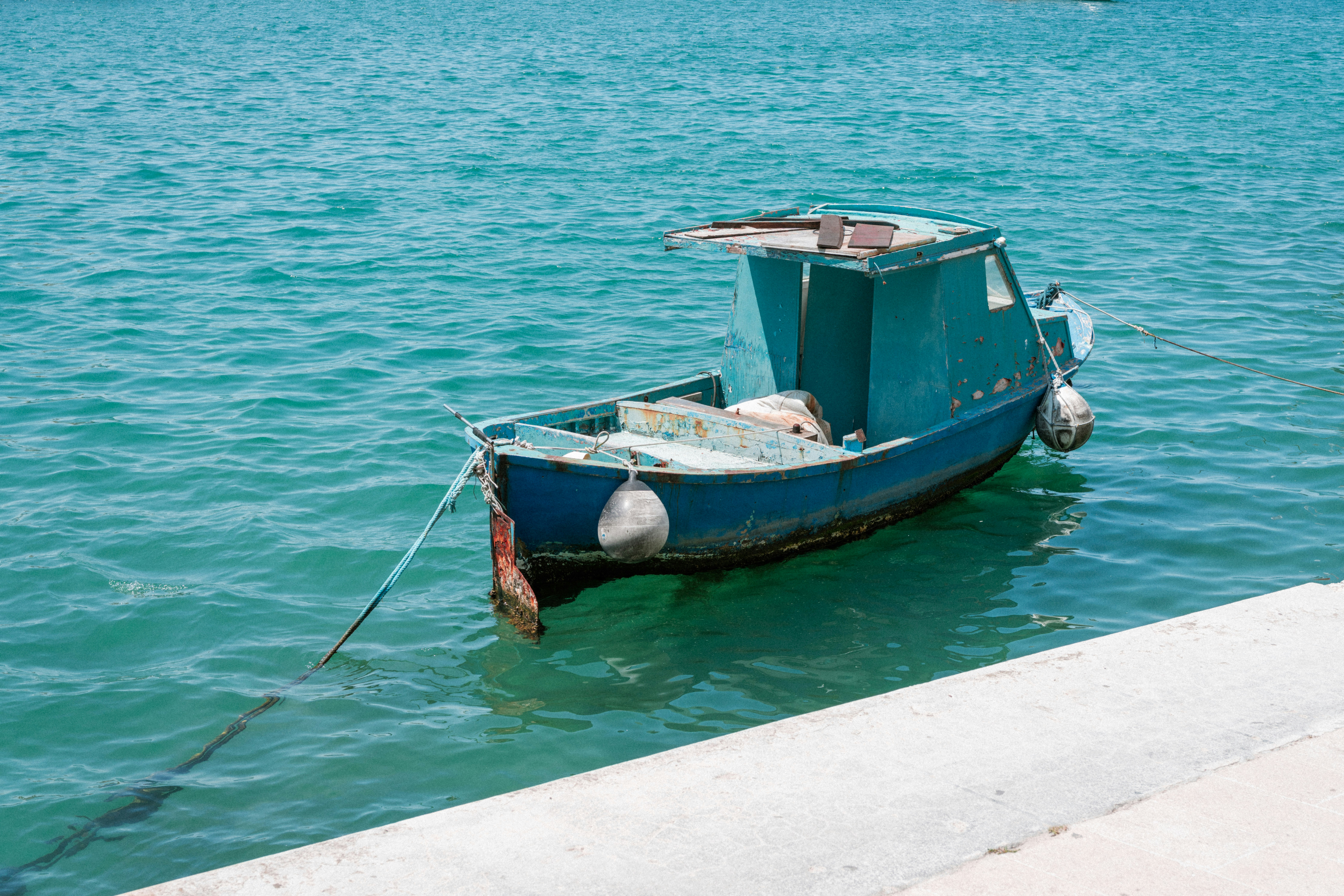 Blue Boat at the Quiet Edge of Turquoise Water