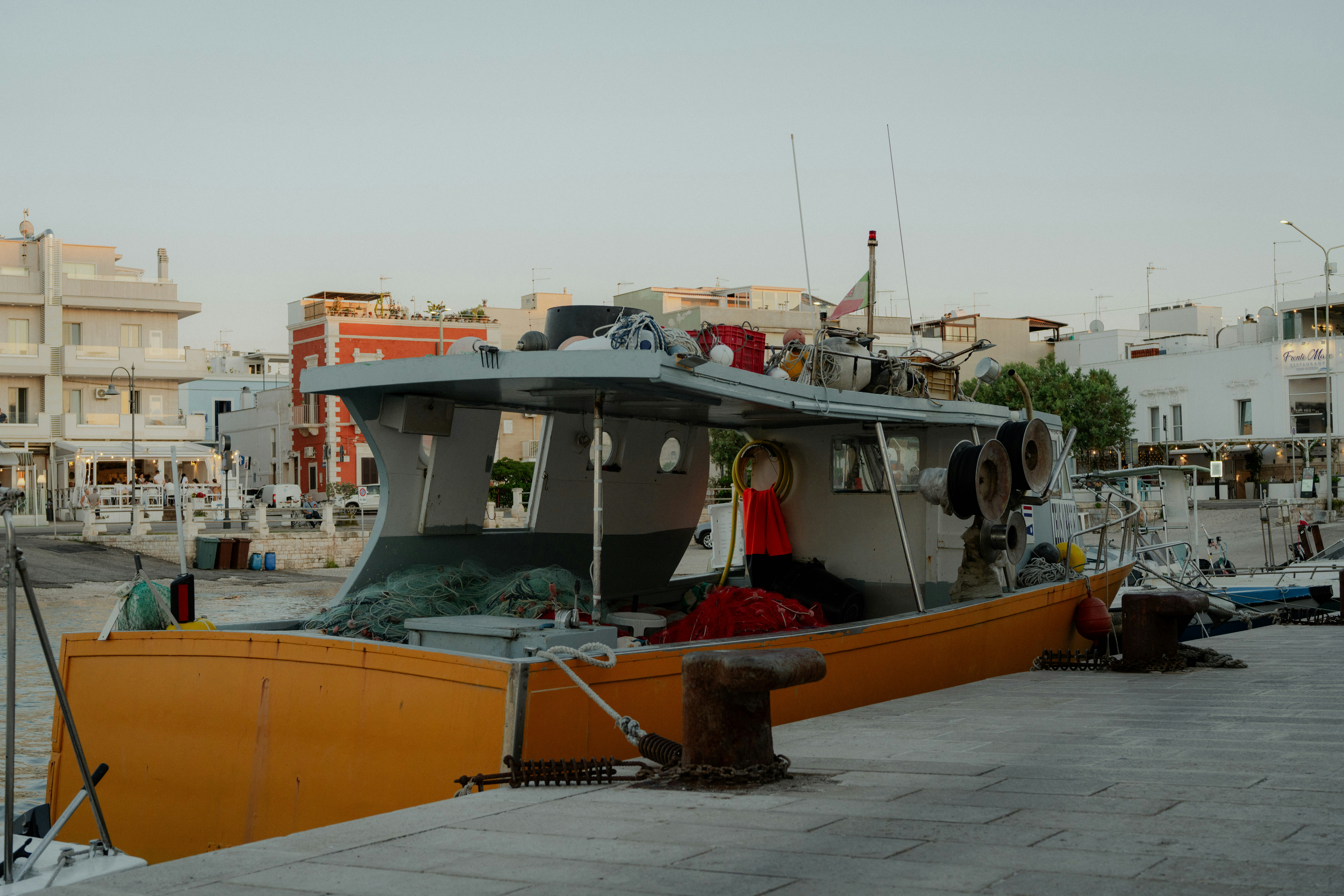 Orange Boat at the Quiet Harbor Front