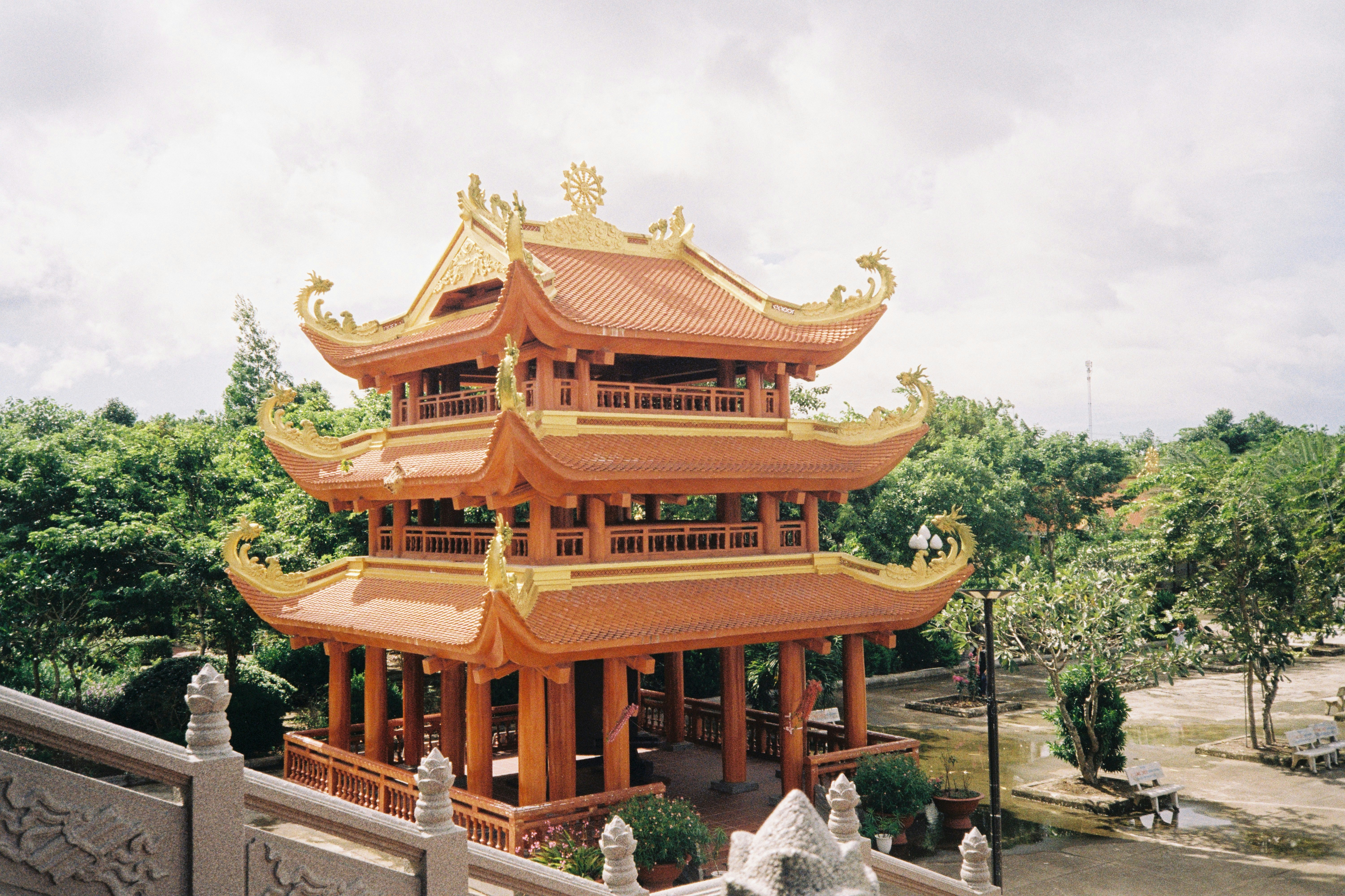 Orange Pagoda Rising: A Multilevel Temple Framed by Lush Grounds