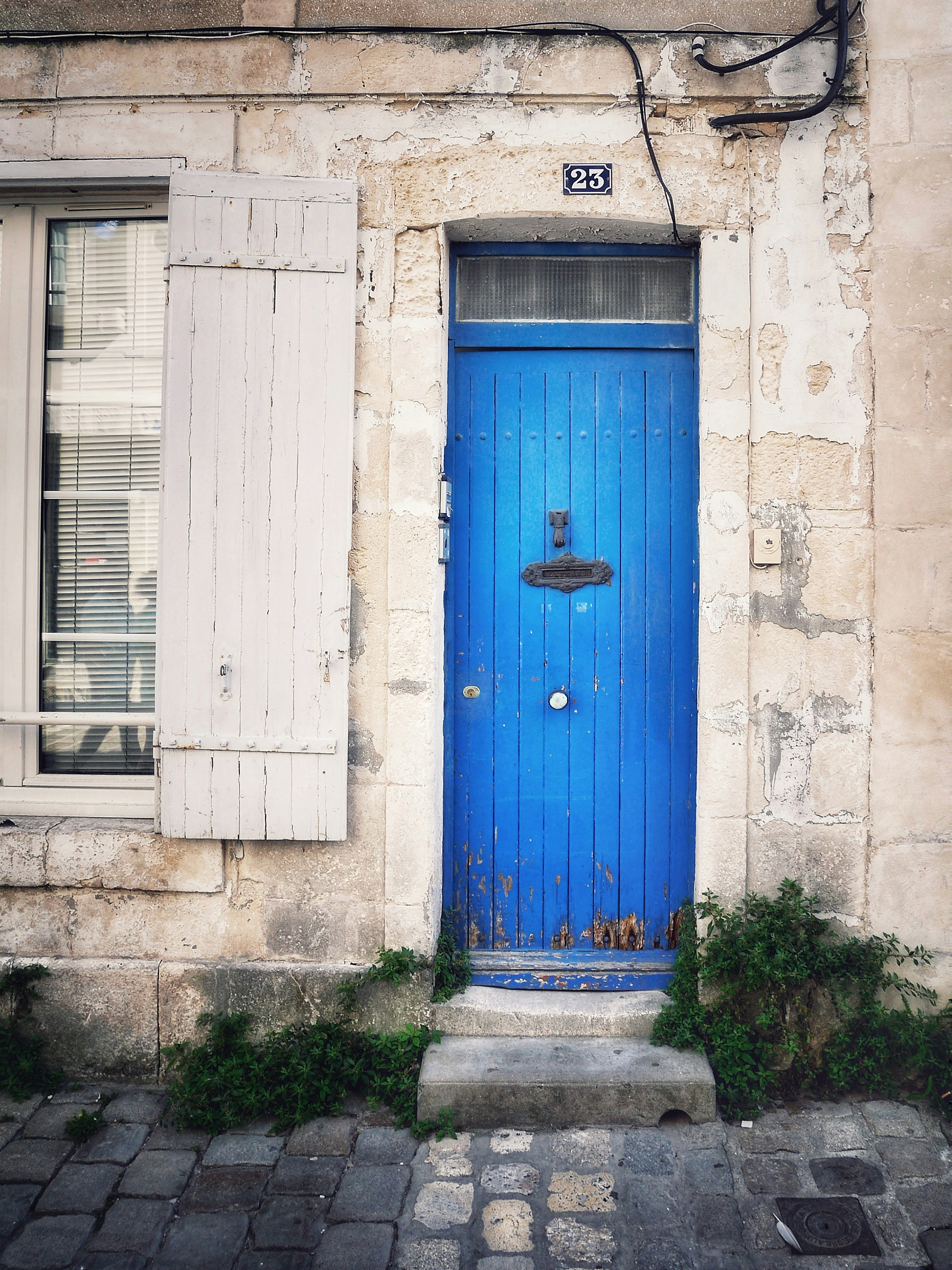 Blue Door on Weathered Stone: A Quiet Facade of a European Street