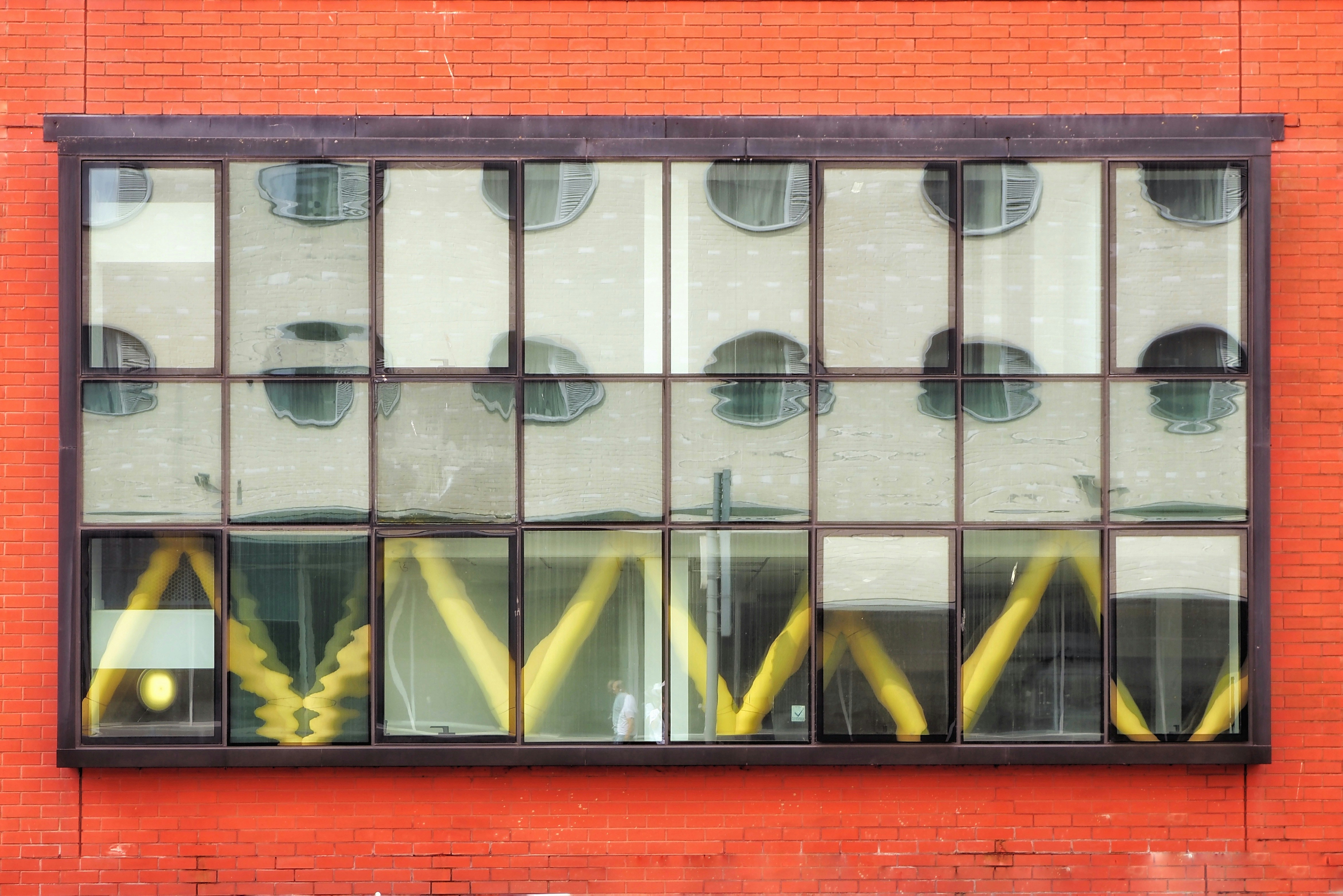 Glass-Panel Reflections in a Red Brick Box