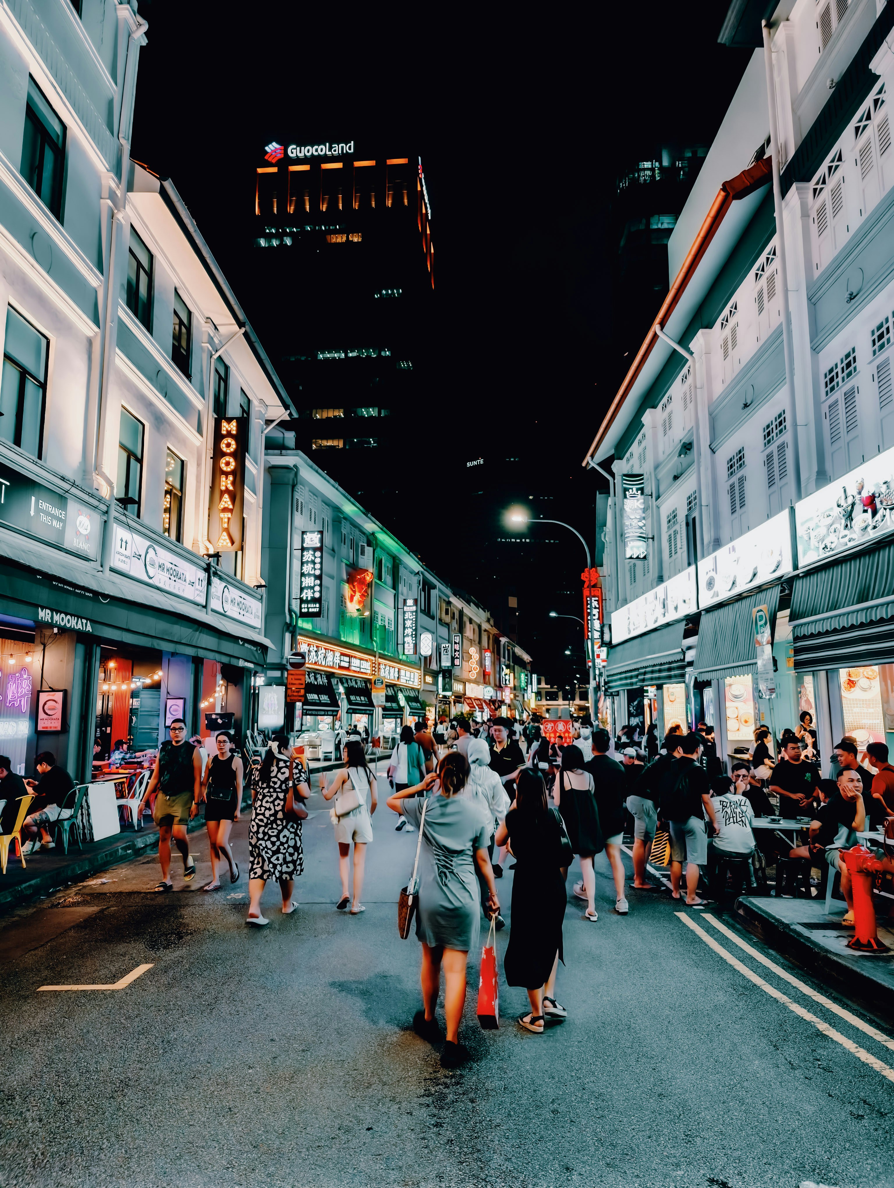City Pulse at Night: Neon Threads through Shoppers' Alley