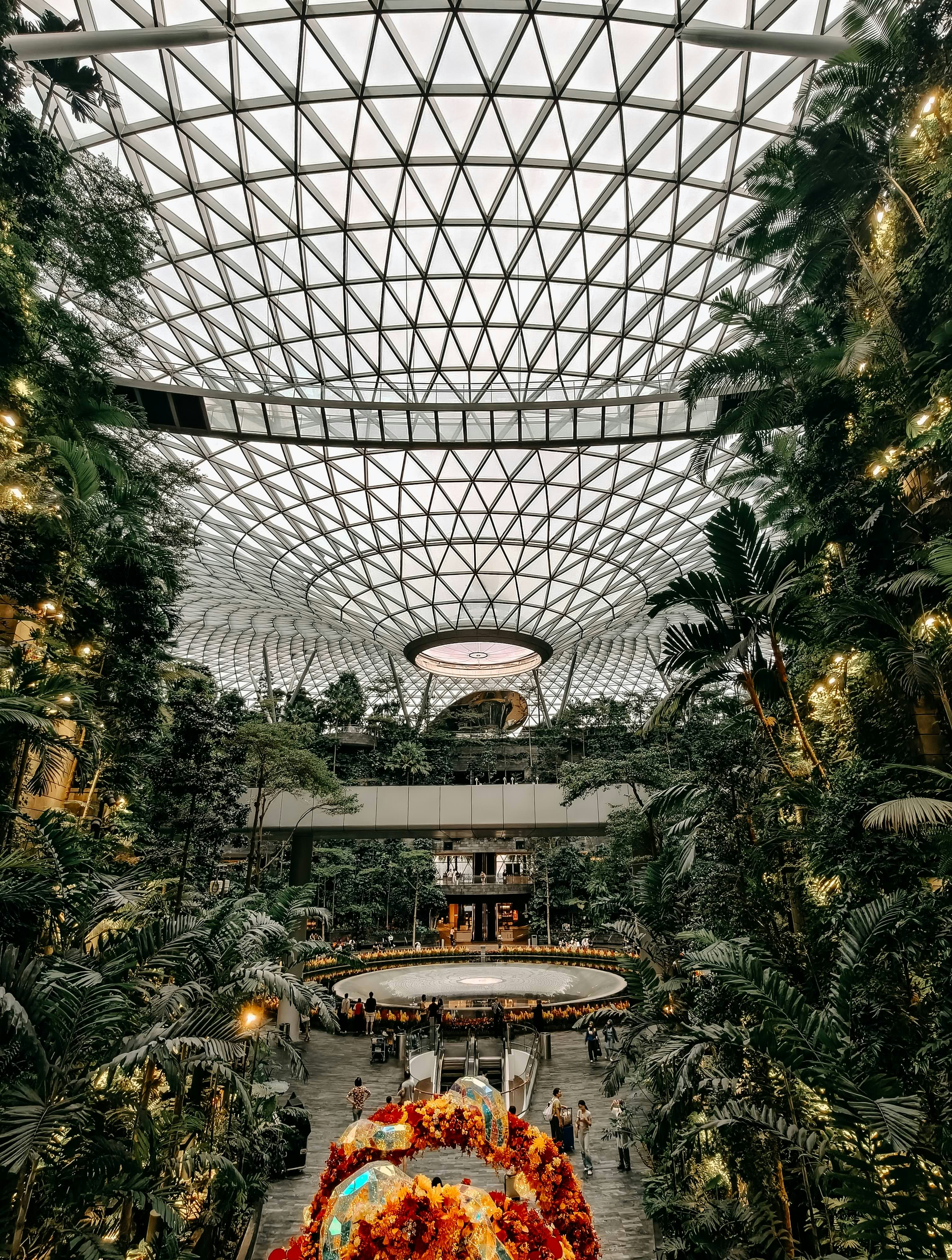 Indoor Rainforest Atrium: Glass Dome Framing a Lush Green Sanctuary