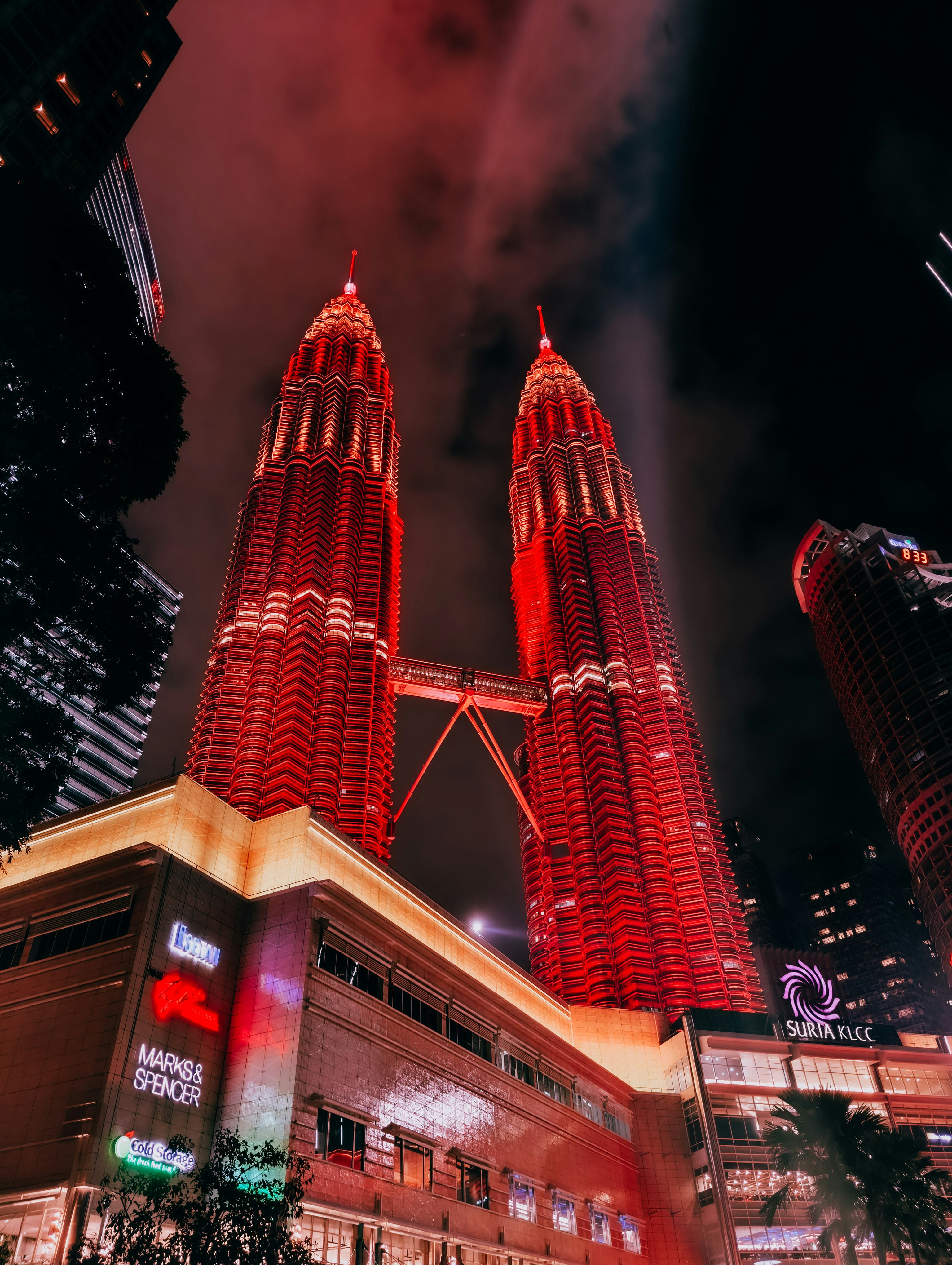 Twin Towers Aglow: Nighttime at the Petronas with Neon Streets