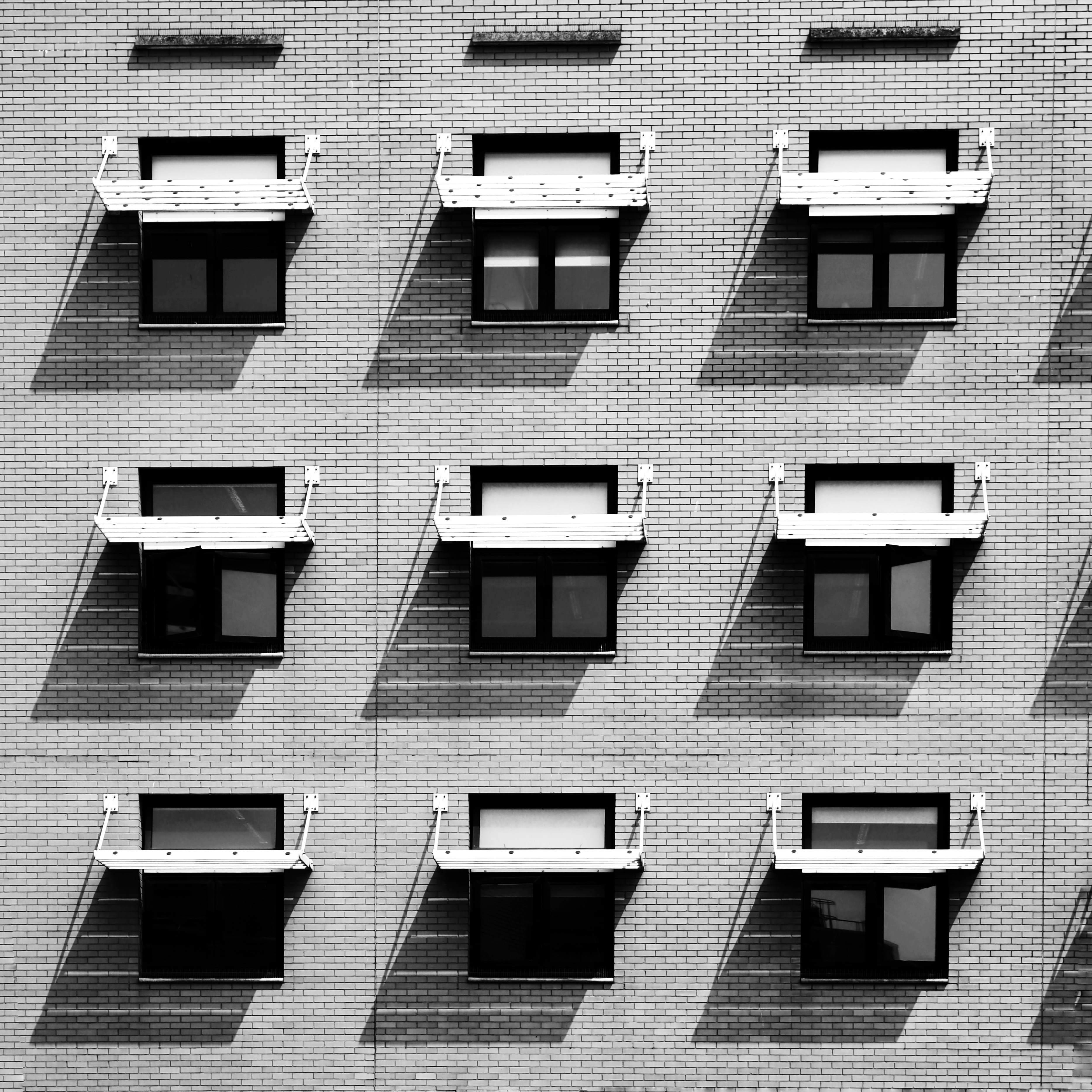 Repetitive Facade: Shadowed Windows in a Grid of Brick