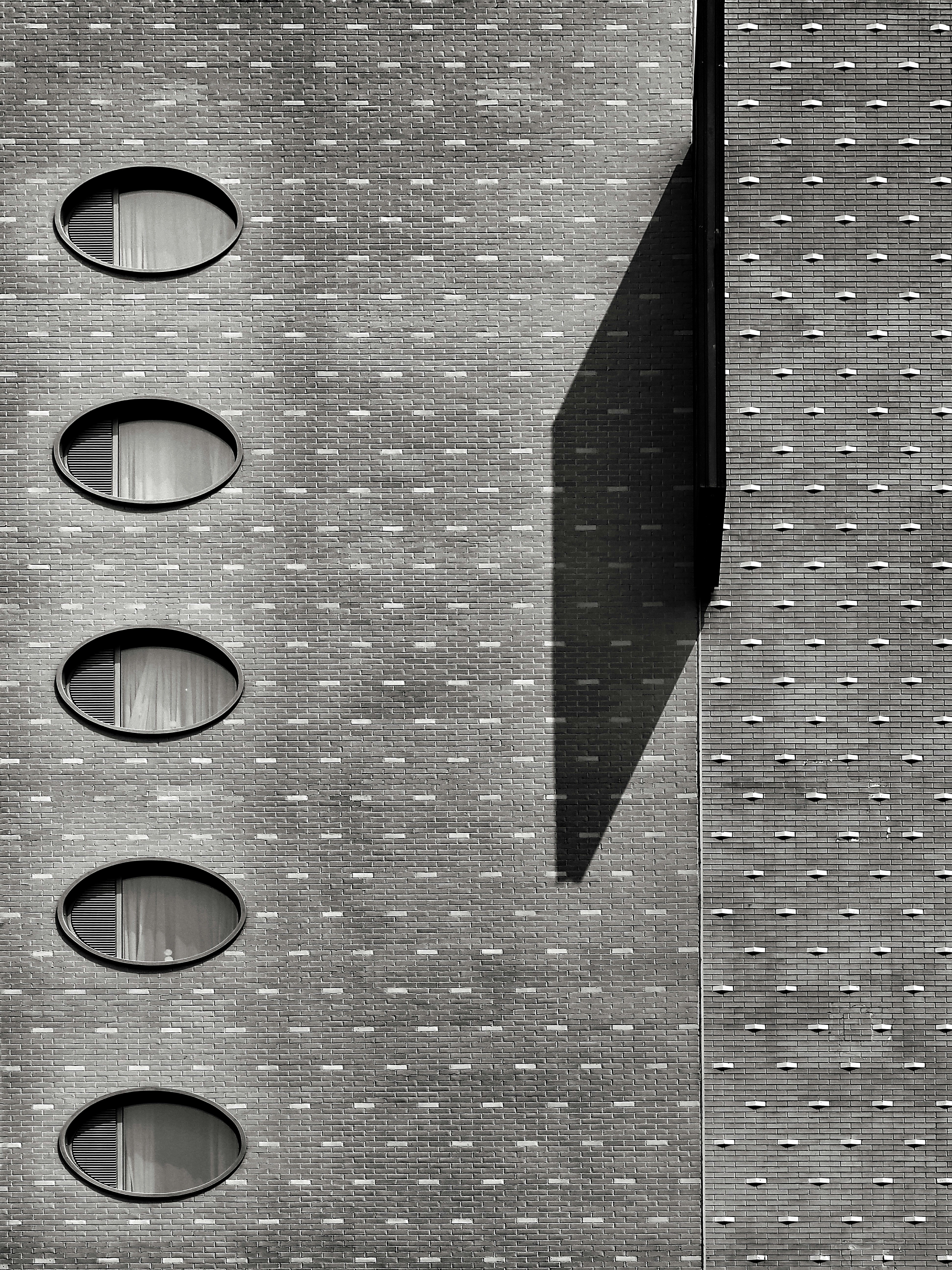 Shadowed Rectangle: A Brick Facade with Circular Windows