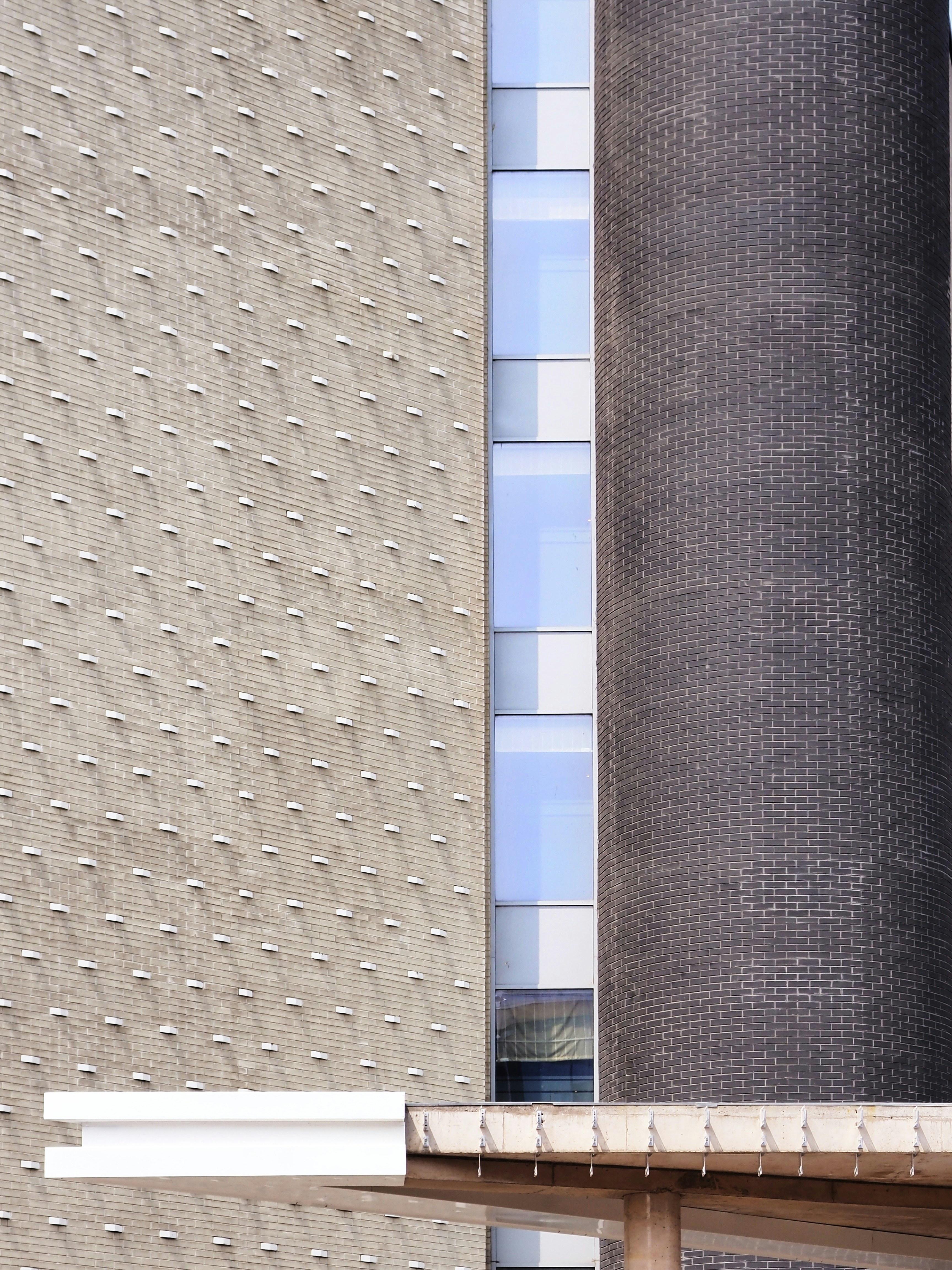 Vertical Vessels: A Facade of Tiles, Glass, and Brick