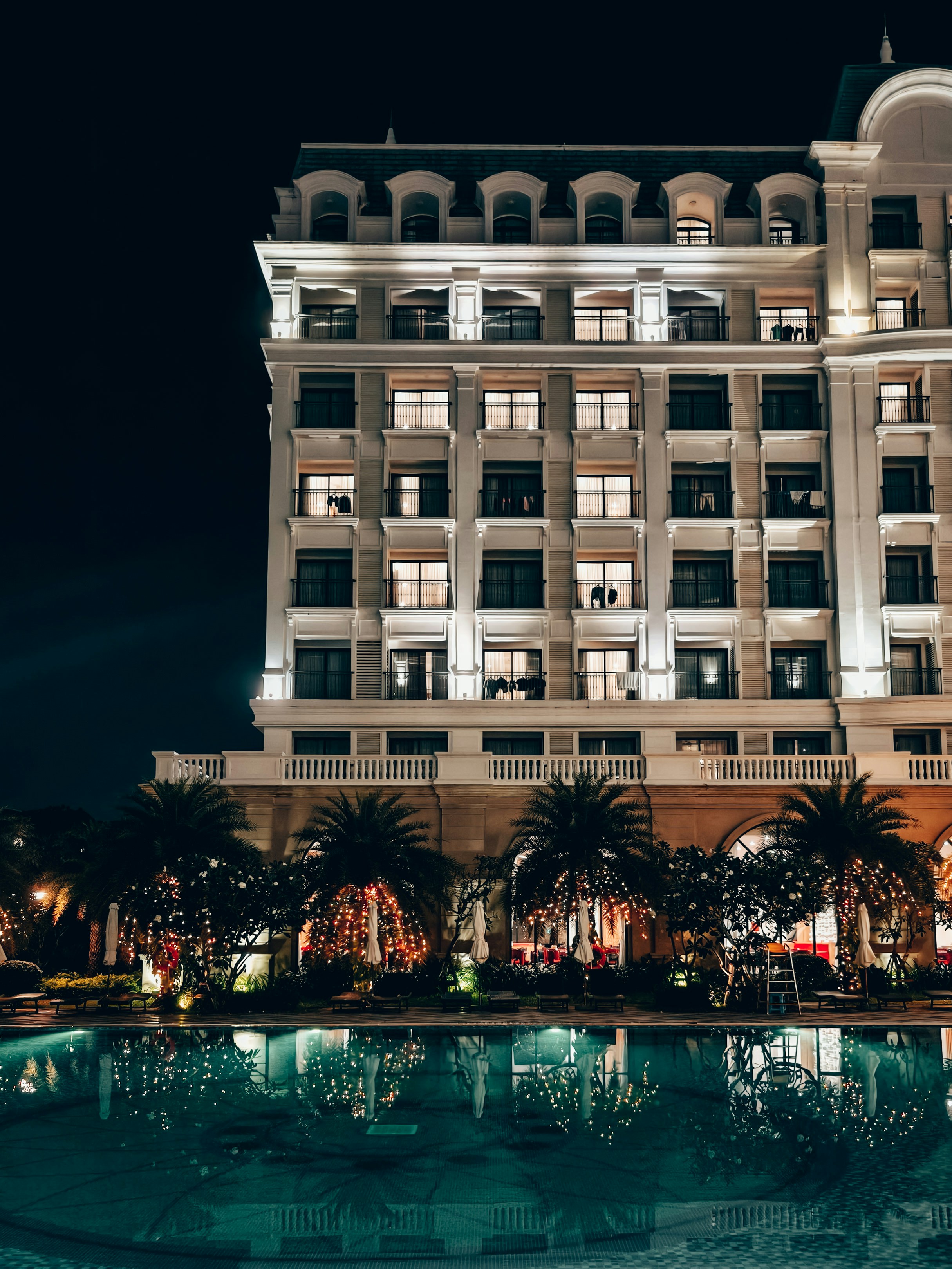 Luminous Facade: Night at the Grand Hotel with Waterfront Glow