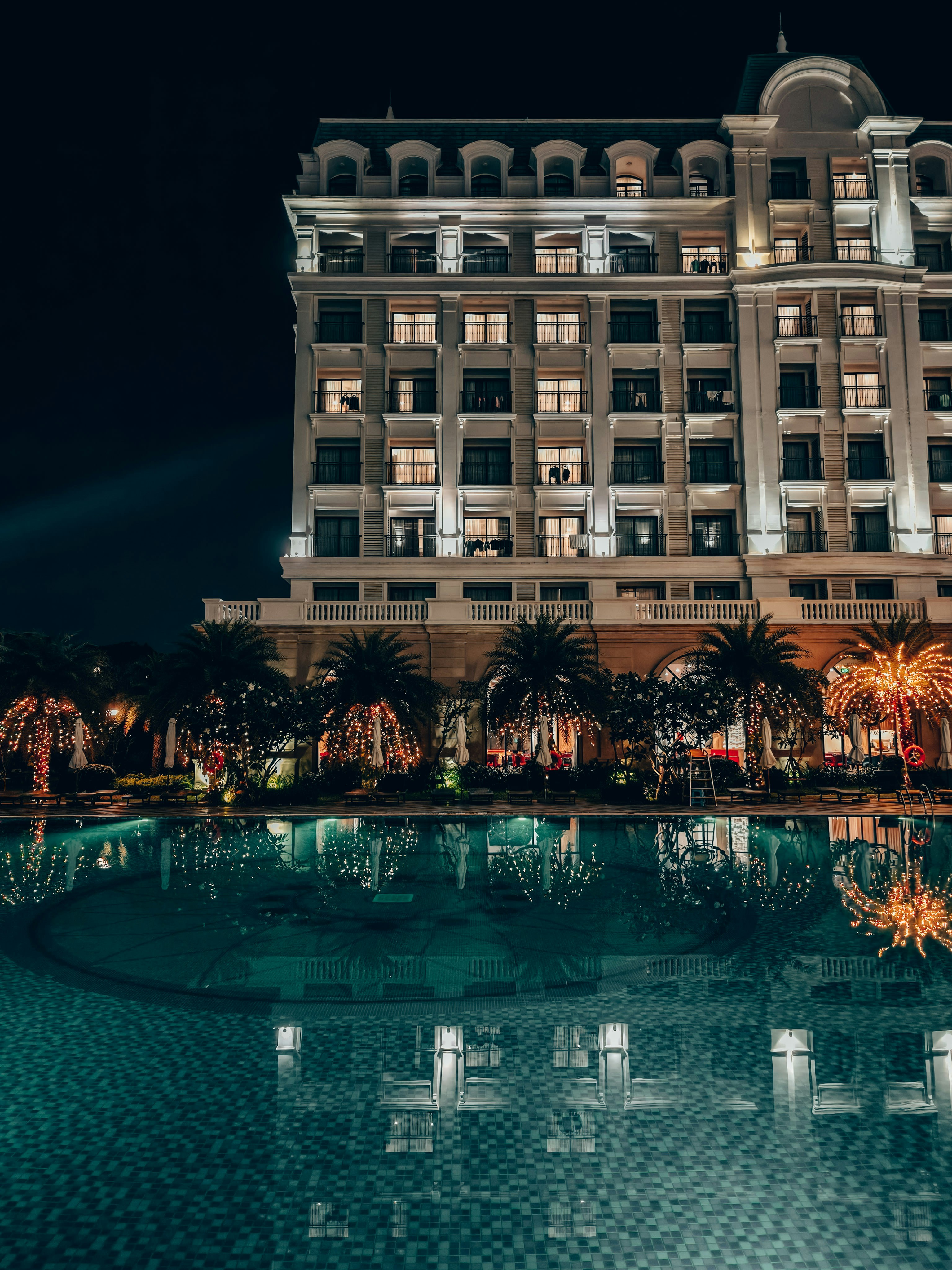 Nighttime Grand Hotel with Reflective Pool Lights