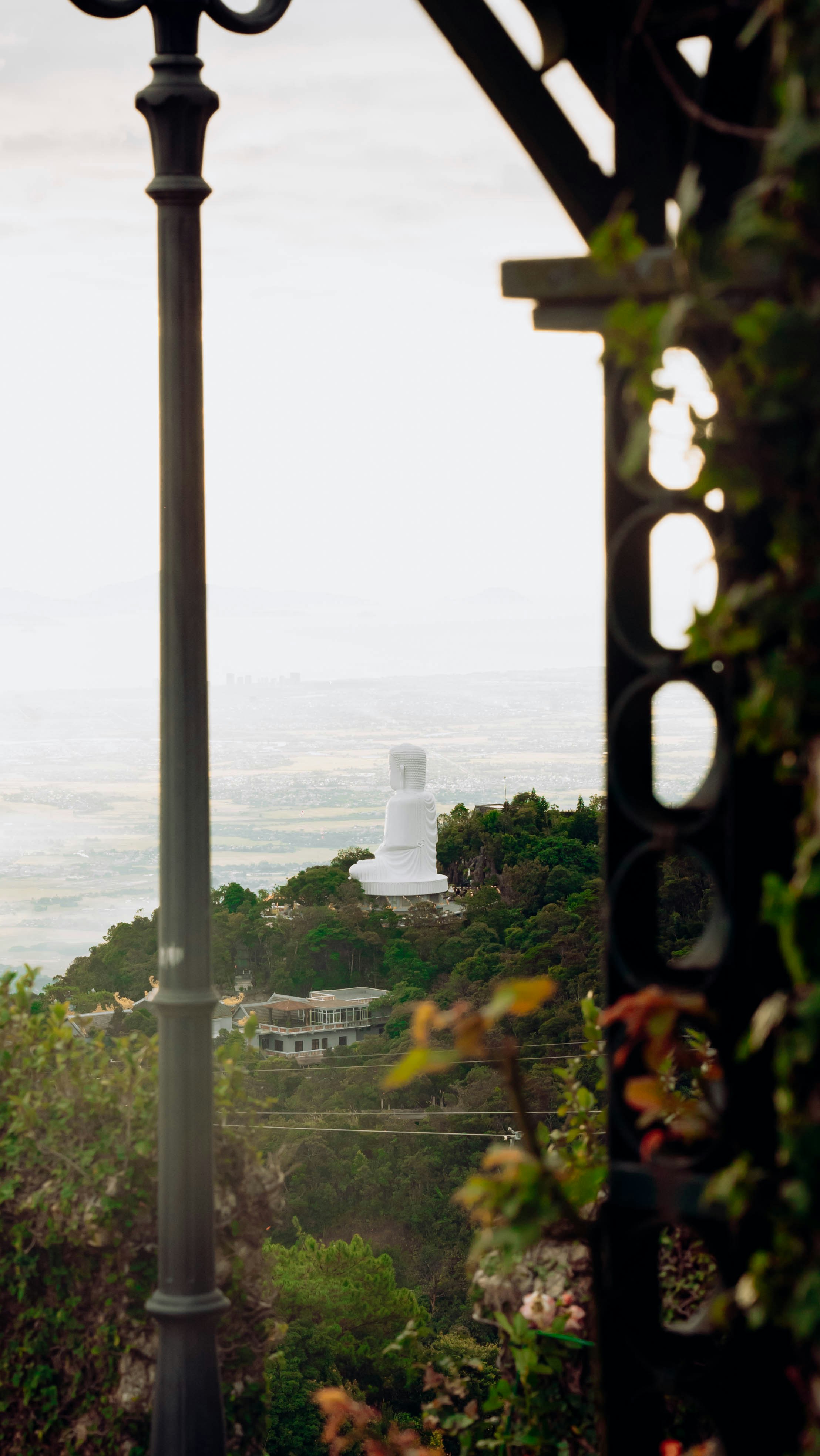 White Pagoda on the Hillside, Framed by Garden Arch