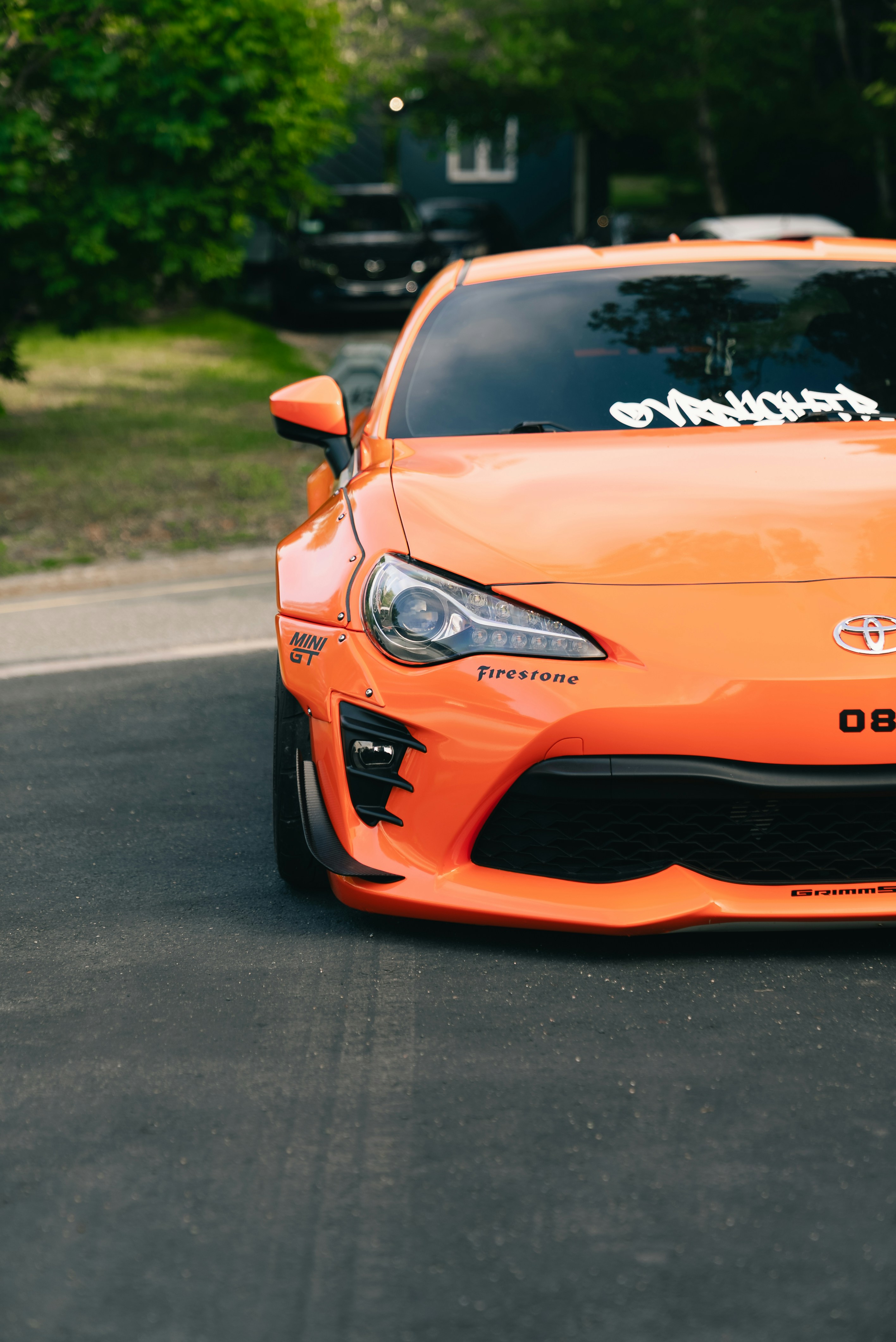 Orange Street Racer: A Bold Front-Quarter Portrait