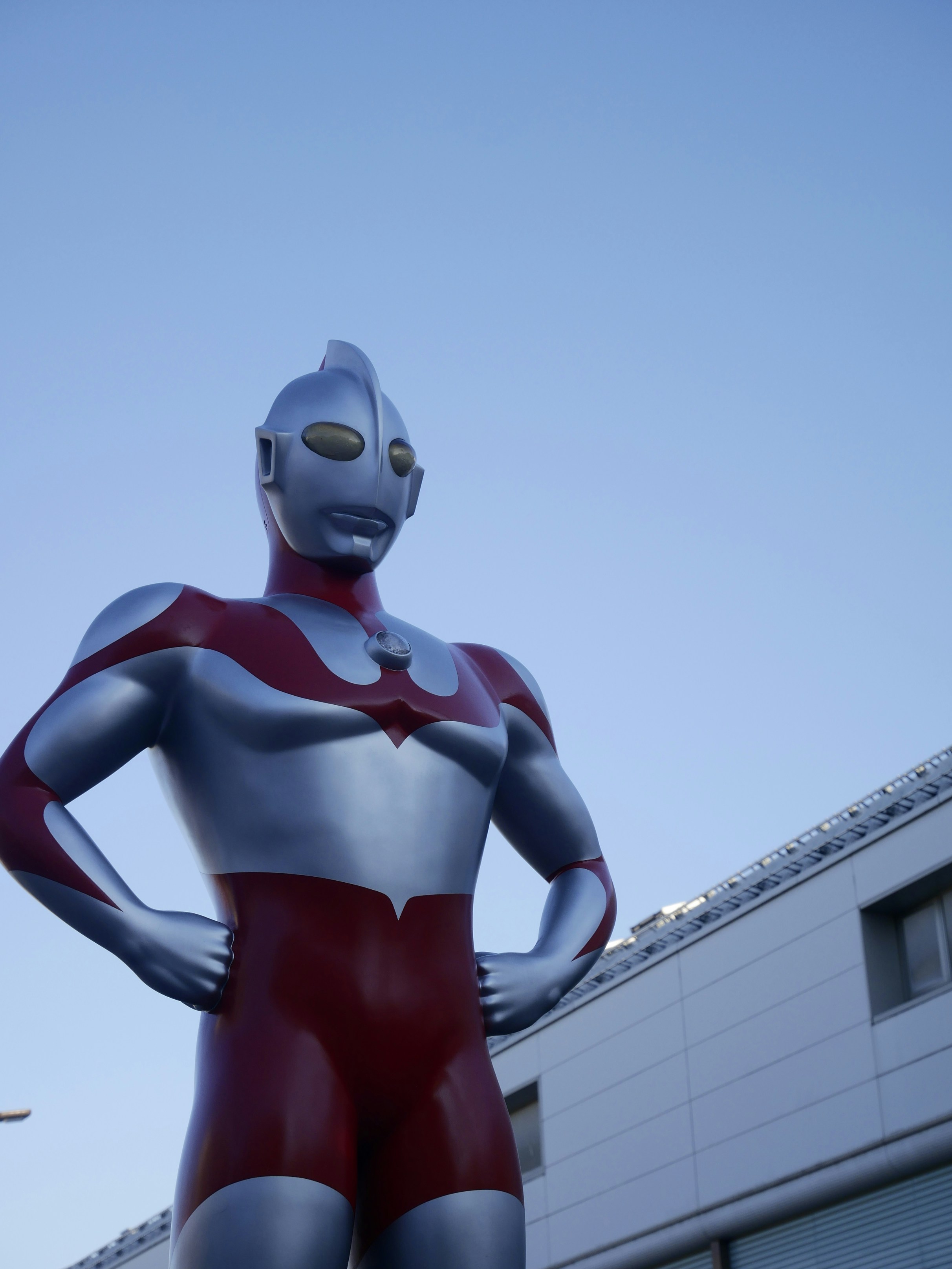Ultraman Stance: A Giant Hero Guarding a Modern Facade