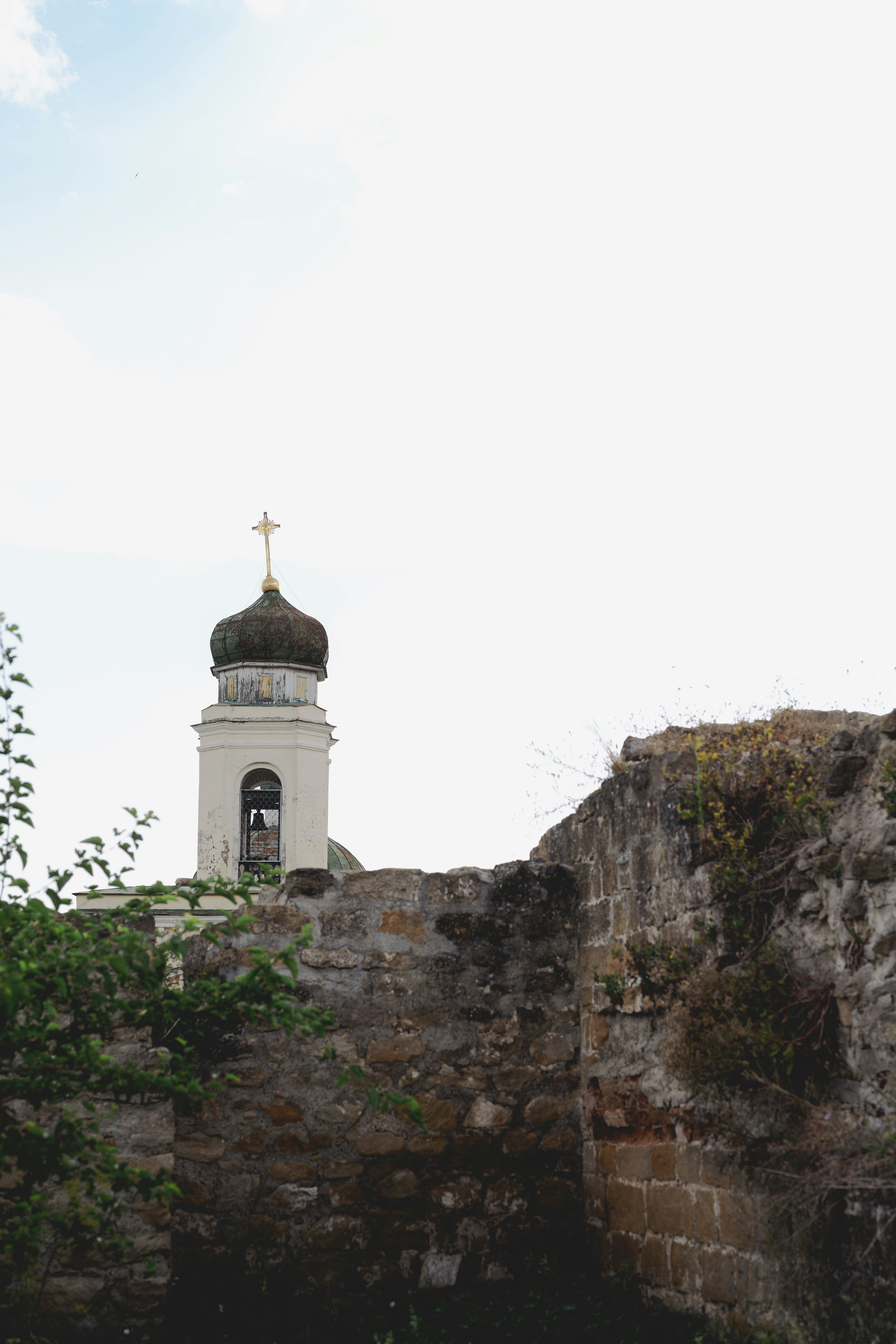 Bell Tower Rising Over Ancient Wall
