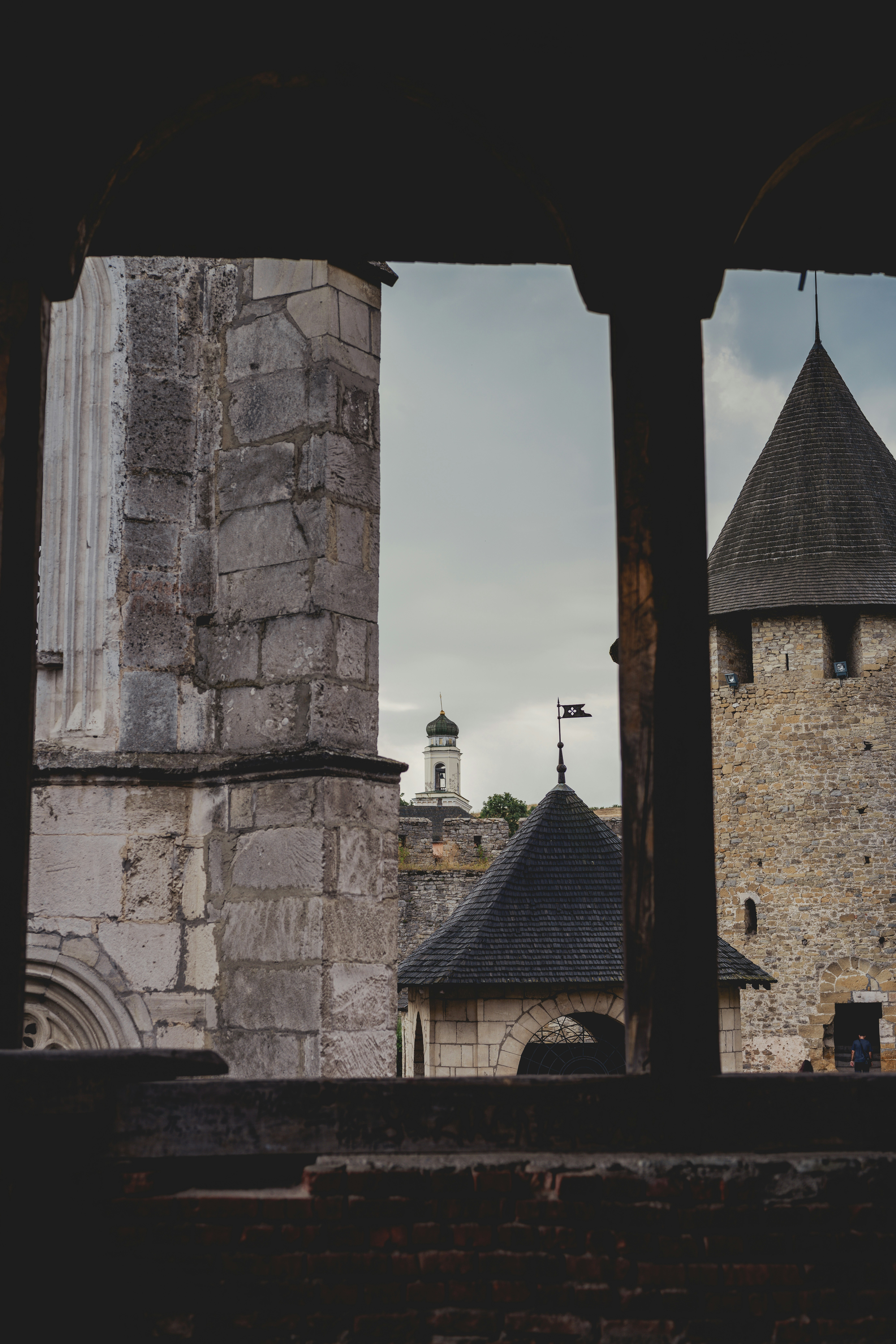 Lighted Window to the Past: A Medieval Courtyard Framed by Stone Arches