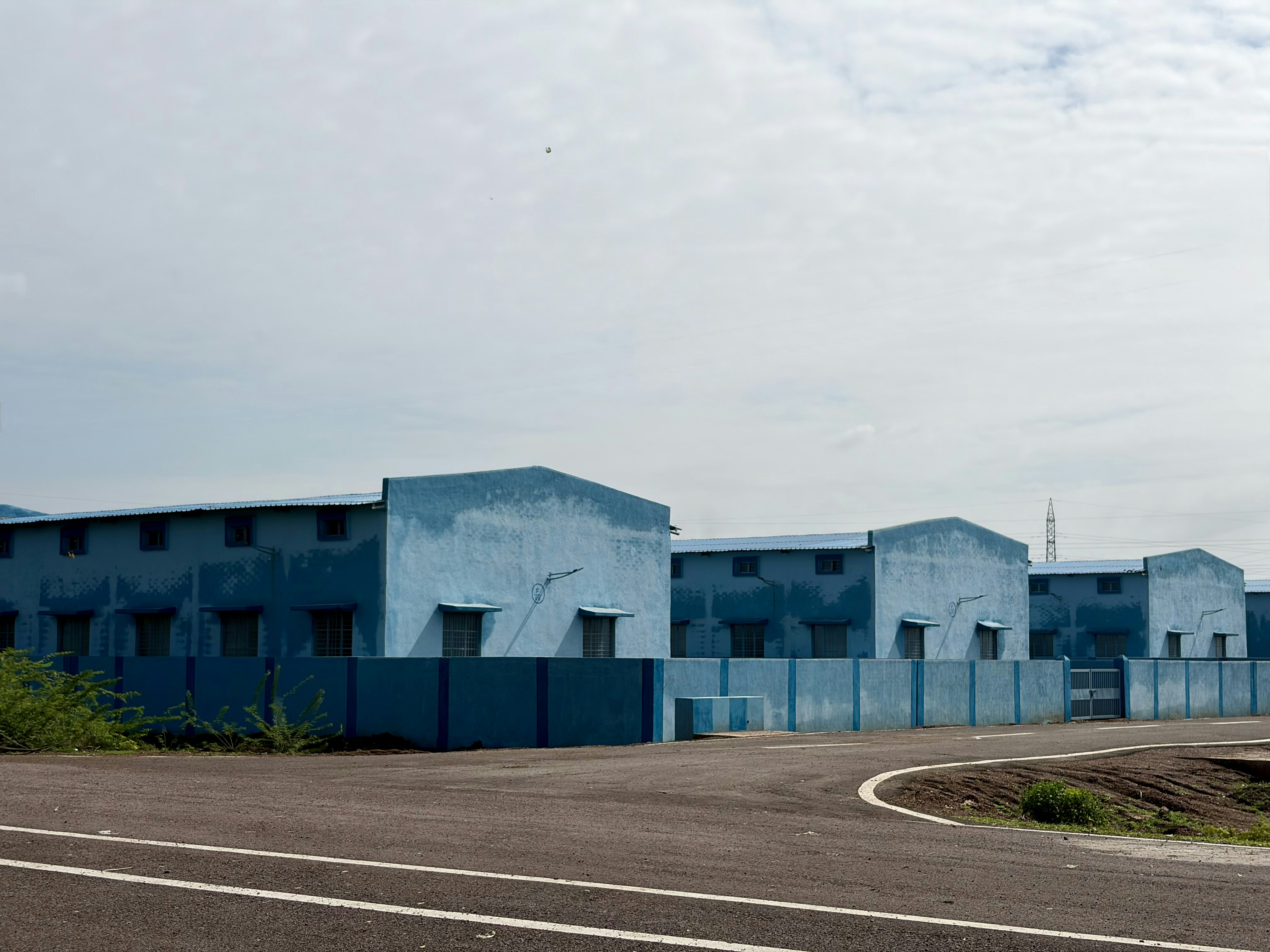Blue Industrial Barricade: Echoes of a Quiet Compound