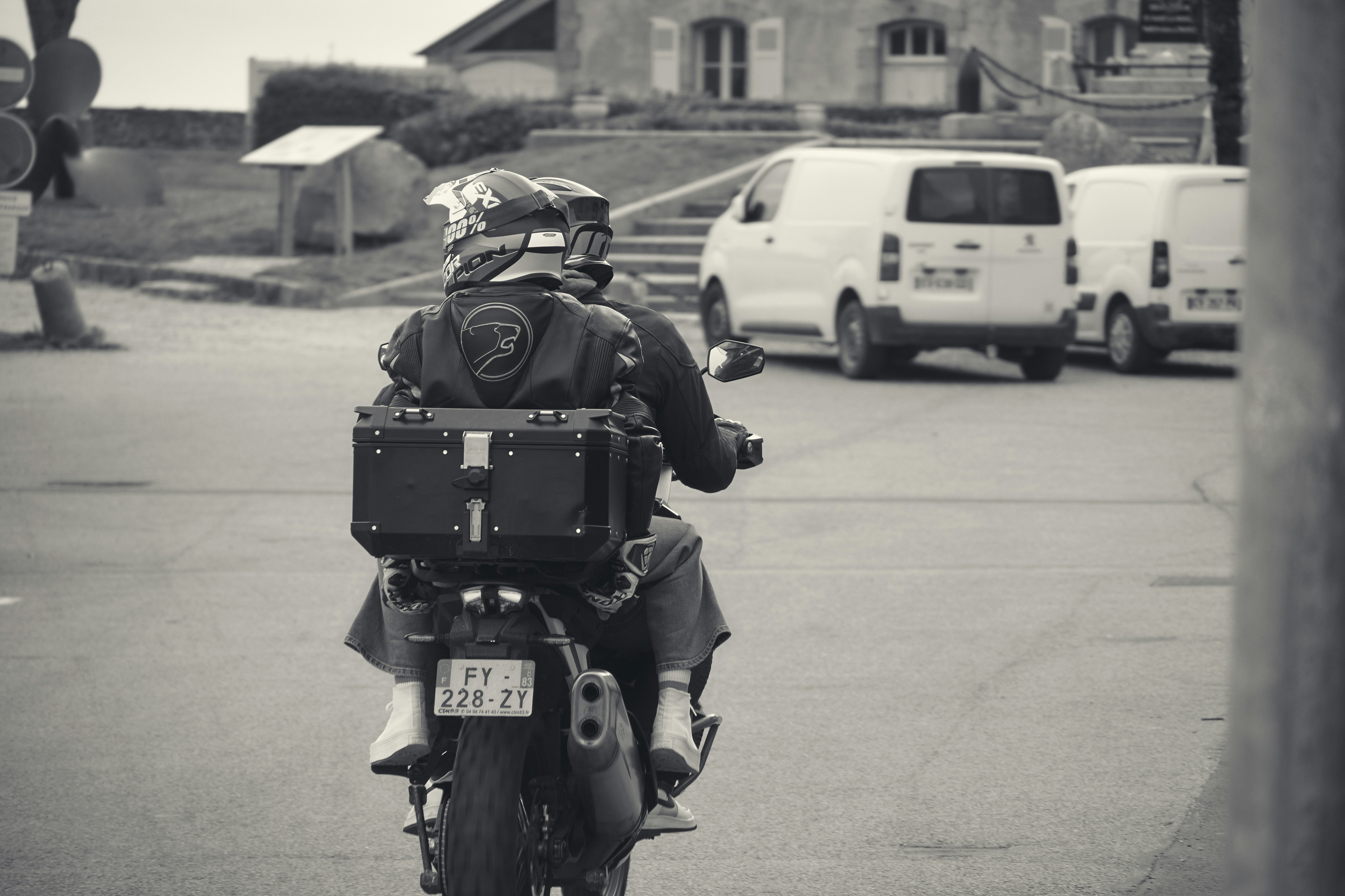 Rear-View Rider: A Helm and Luggage Scene on a Quiet Street