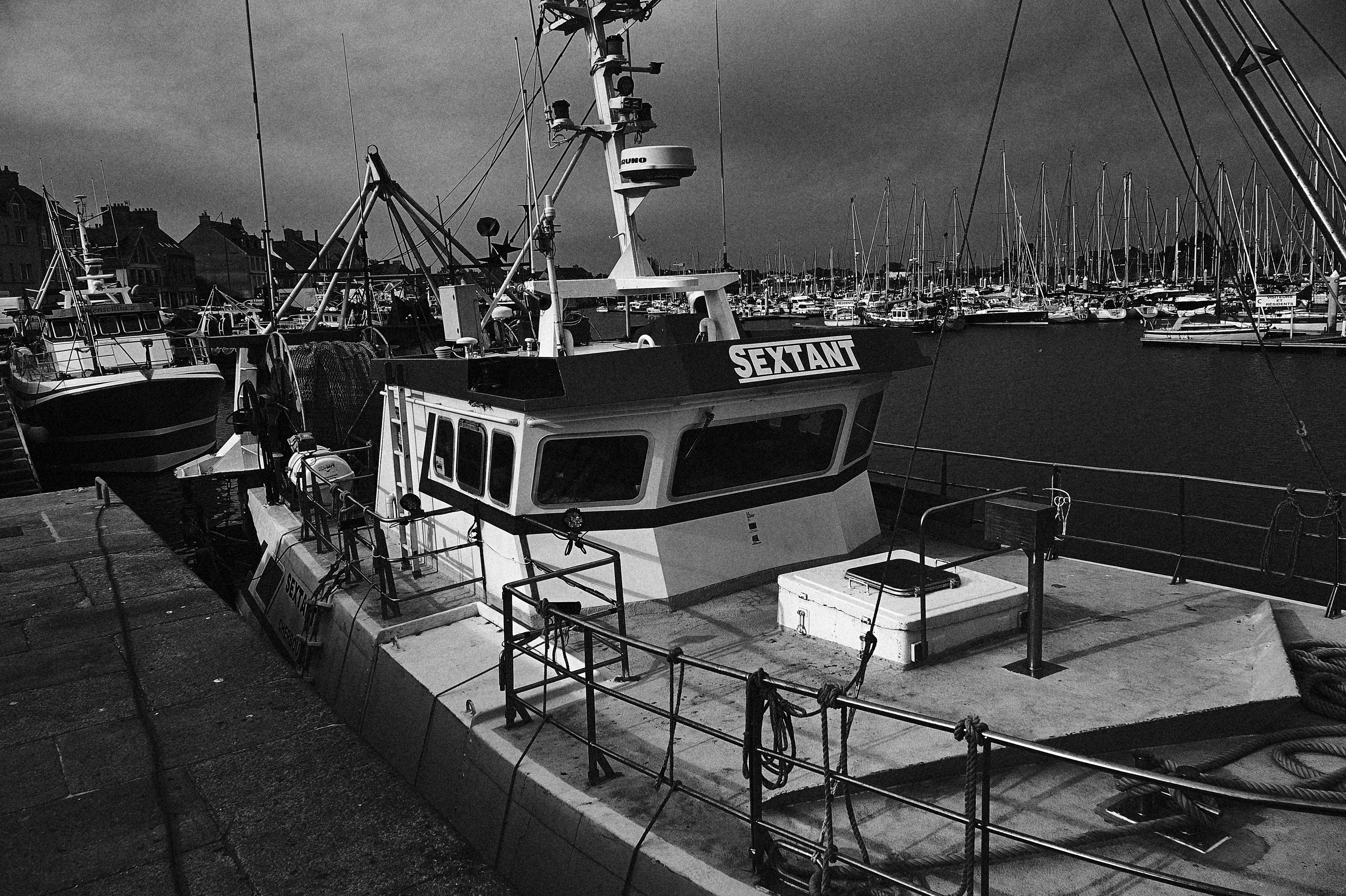 Dockside Ghosts: The Weathered Workboat at the Quiet Pier